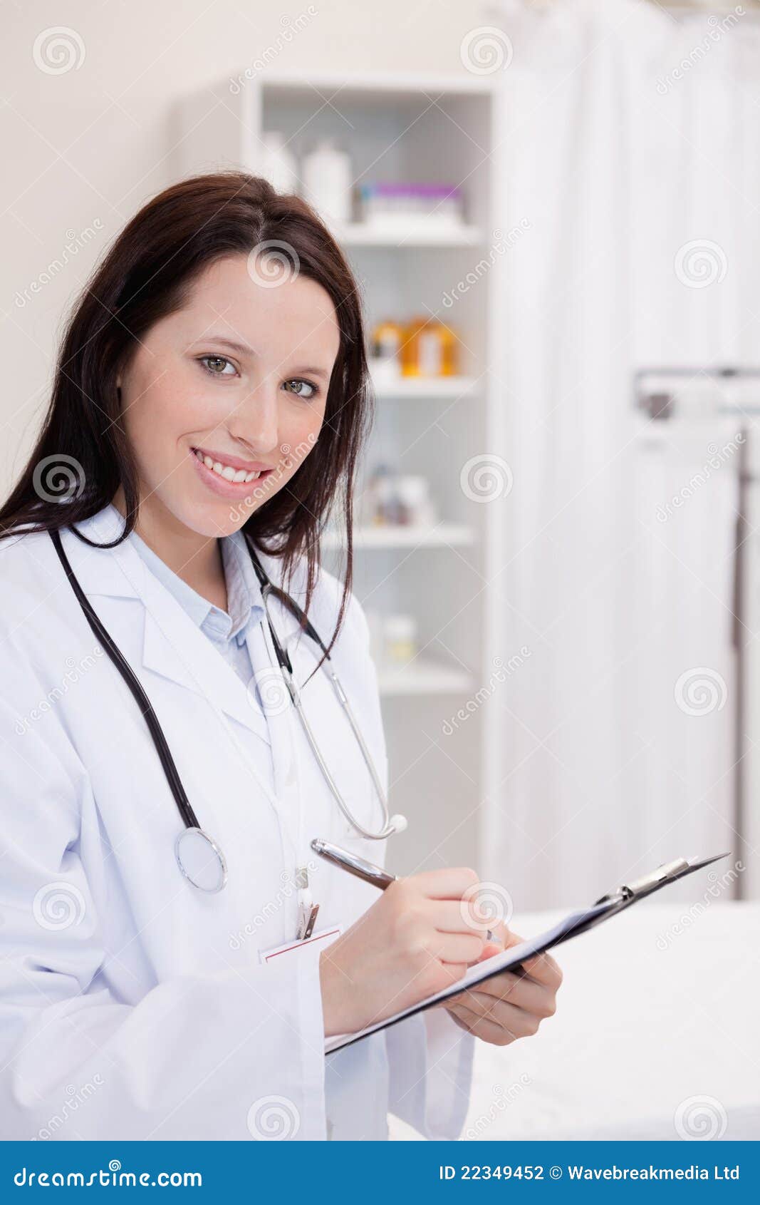Smiling Female Doctor Taking Notes Stock Photo - Image of care, medic ...