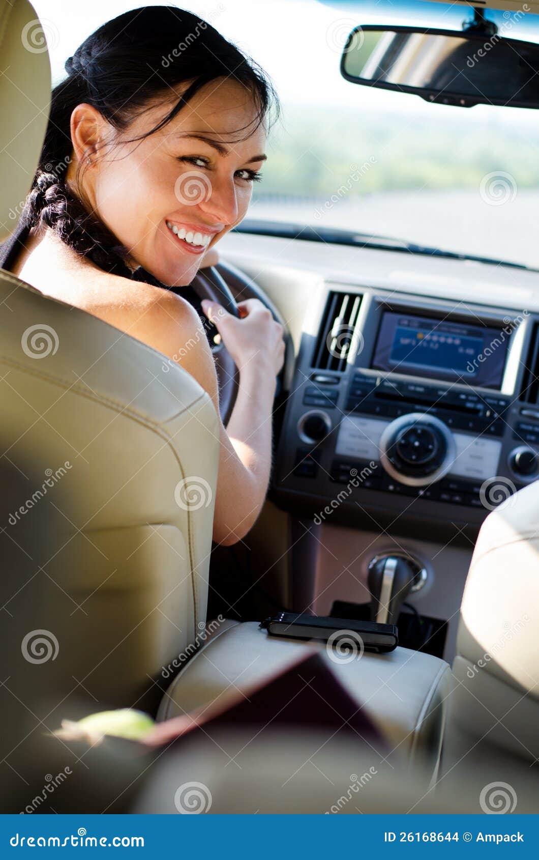 Smiling Female Driver Looking Over Her Shoulder Stock Photo - Image of ...