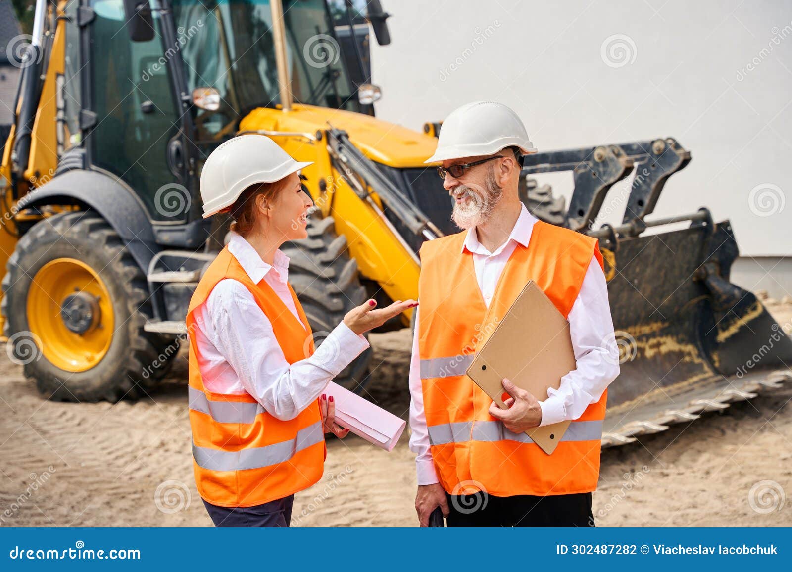 Two Construction Specialists Having Conversation on Building Site Stock ...