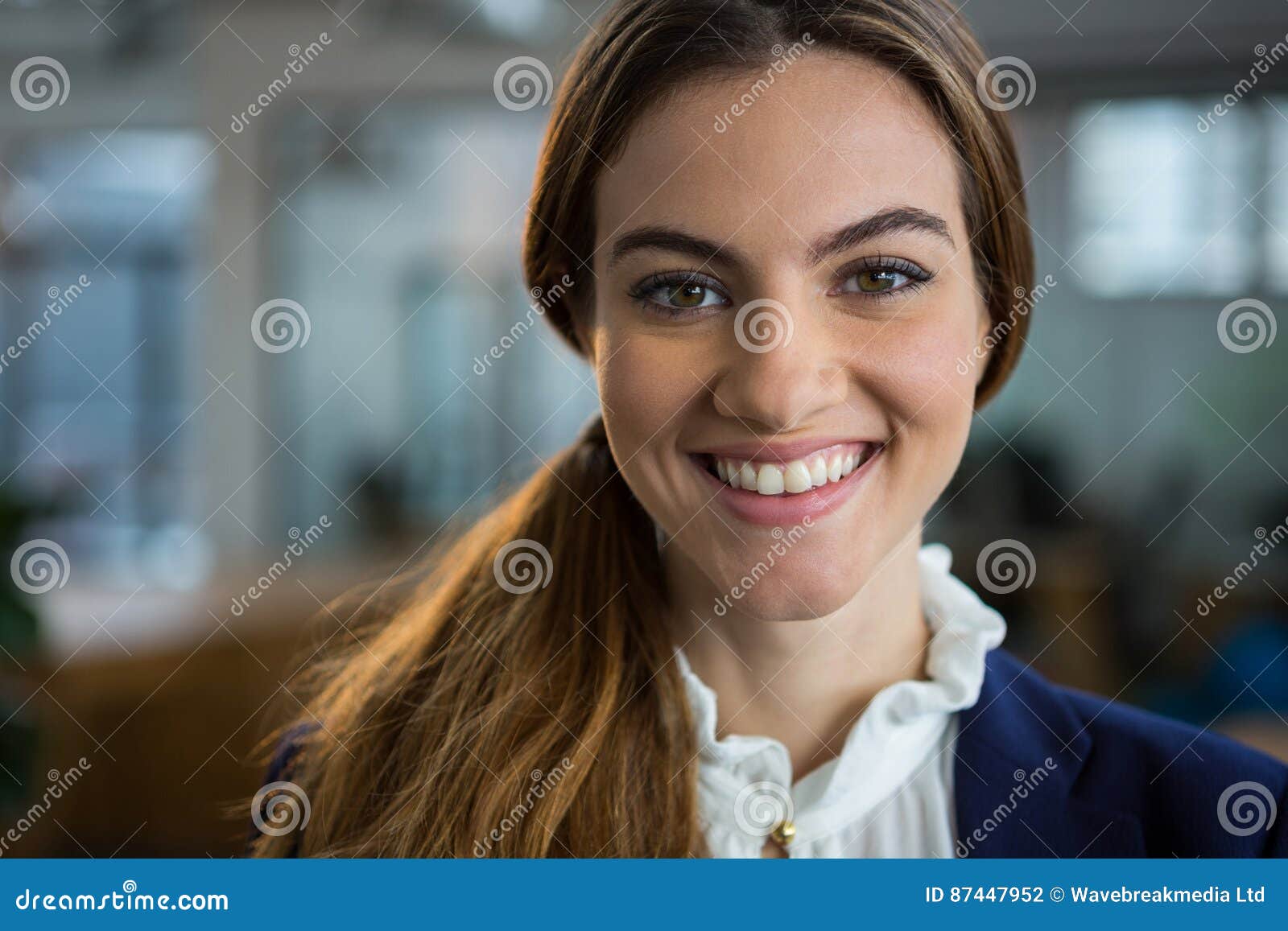 Smiling Female Executive Standing in Creative Office Stock Photo ...