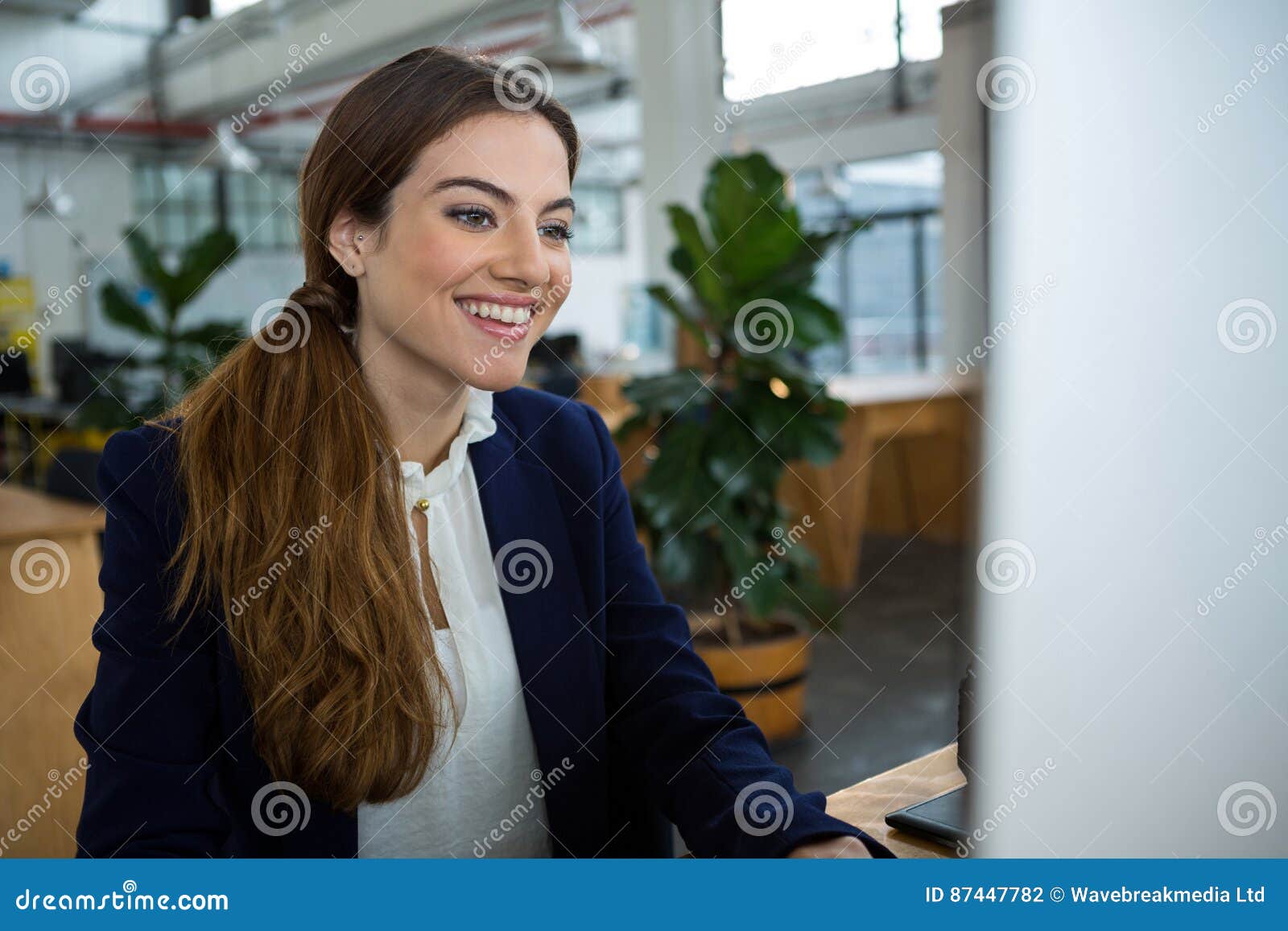 Smiling Female Executive Working on Computer Stock Photo - Image of ...