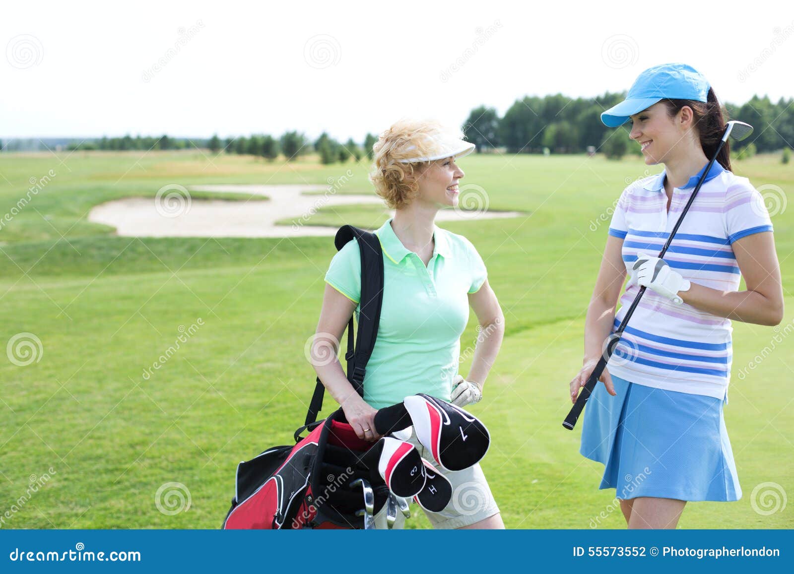 Smiling Female Golfers Talking at Golf Course Stock Photo - Image of ...