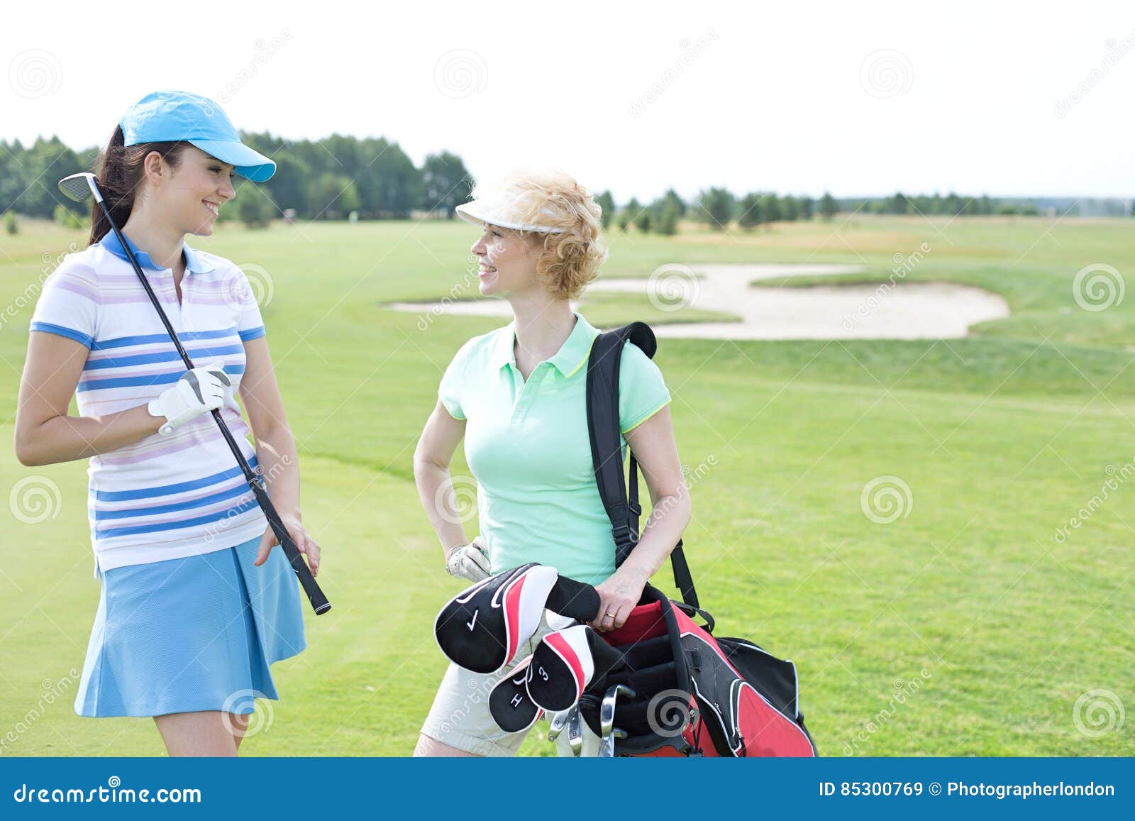 Smiling Female Golfers Talking at Golf Course Stock Image - Image of ...
