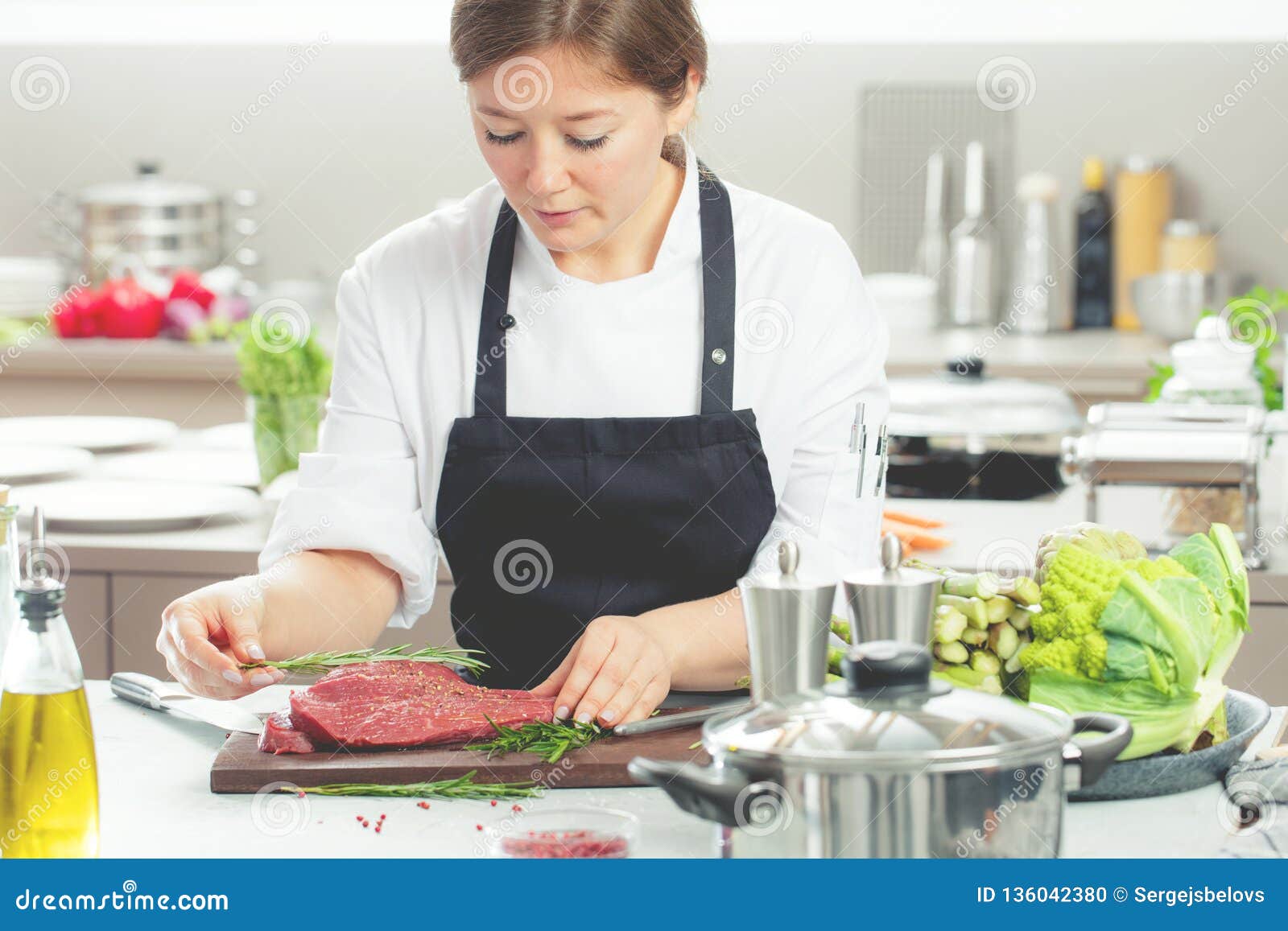 Smiling Female Kitchener in Uniform is Standing in the Kitchen at the ...