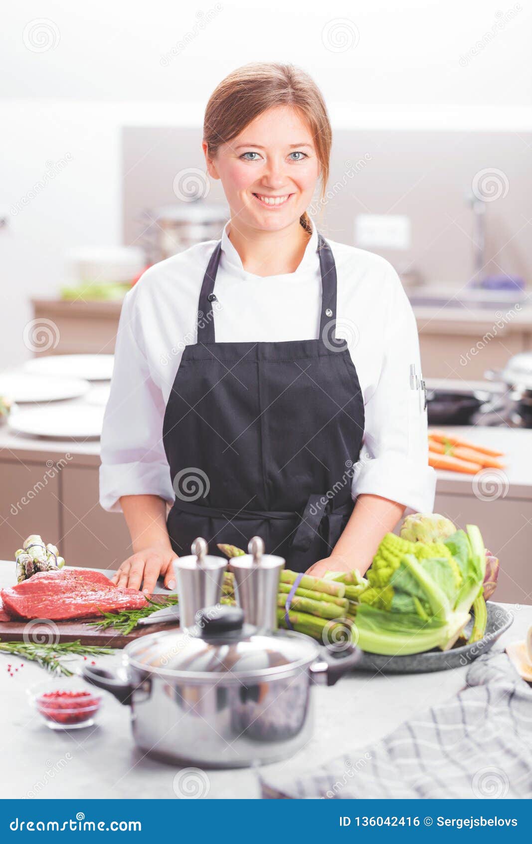 Smiling Female Kitchener in Uniform is Standing in the Kitchen at the ...