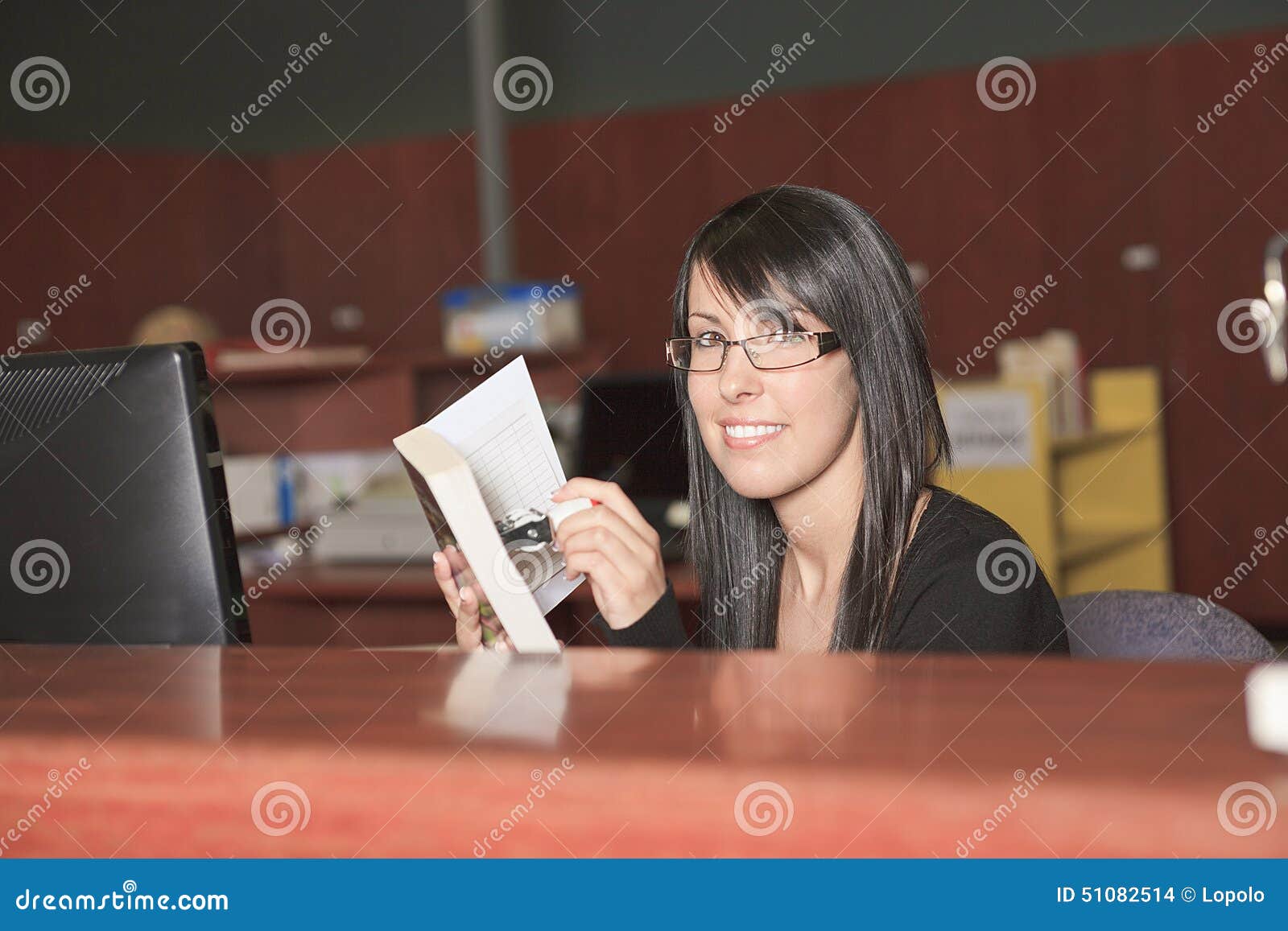 Smiling Female Librarian Holding a Book Standing Stock Photo - Image of ...