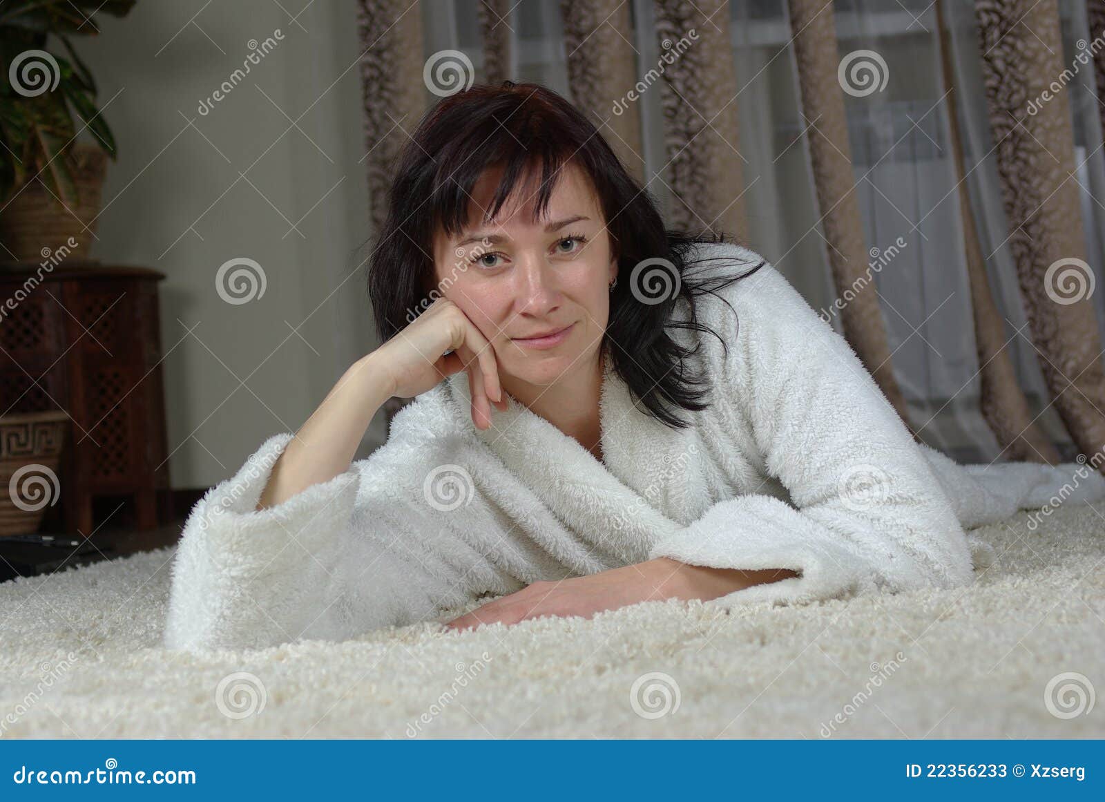 Smiling Female Lying on a Carpet Stock Image - Image of dressing, light ...
