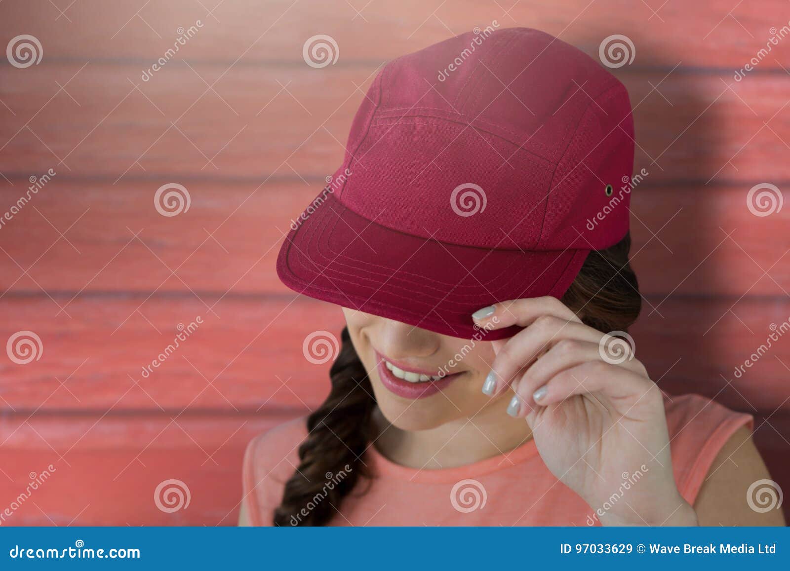 Composite Image of Smiling Female Model Showing Red Cap Stock Image ...