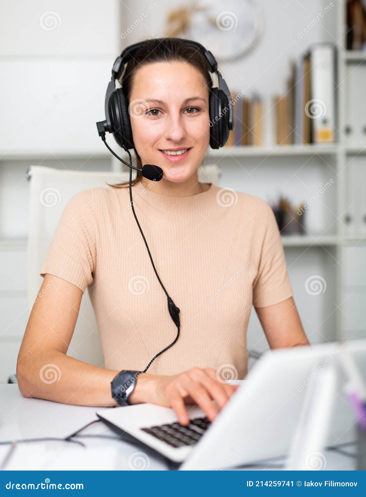 Smiling Female Operator Talking with Customer Using Headset at Office ...