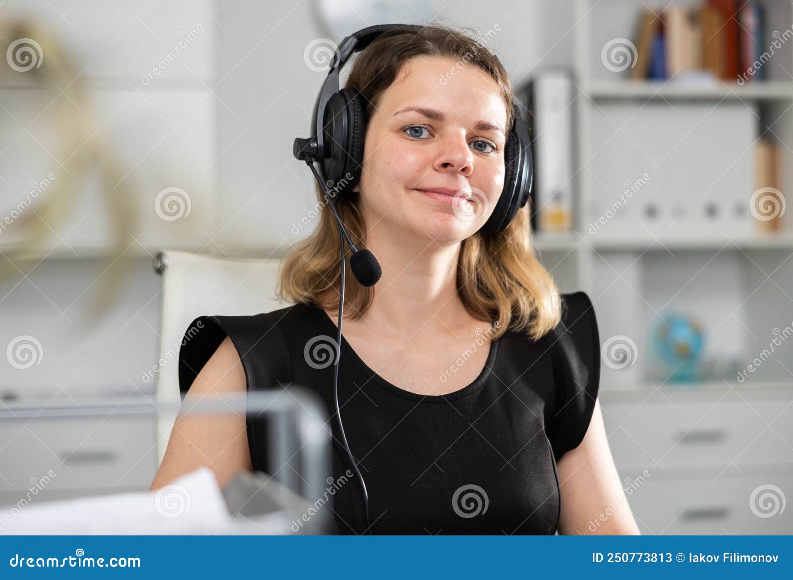 Smiling Female Operator Talking with Customer Using Headset at Company ...
