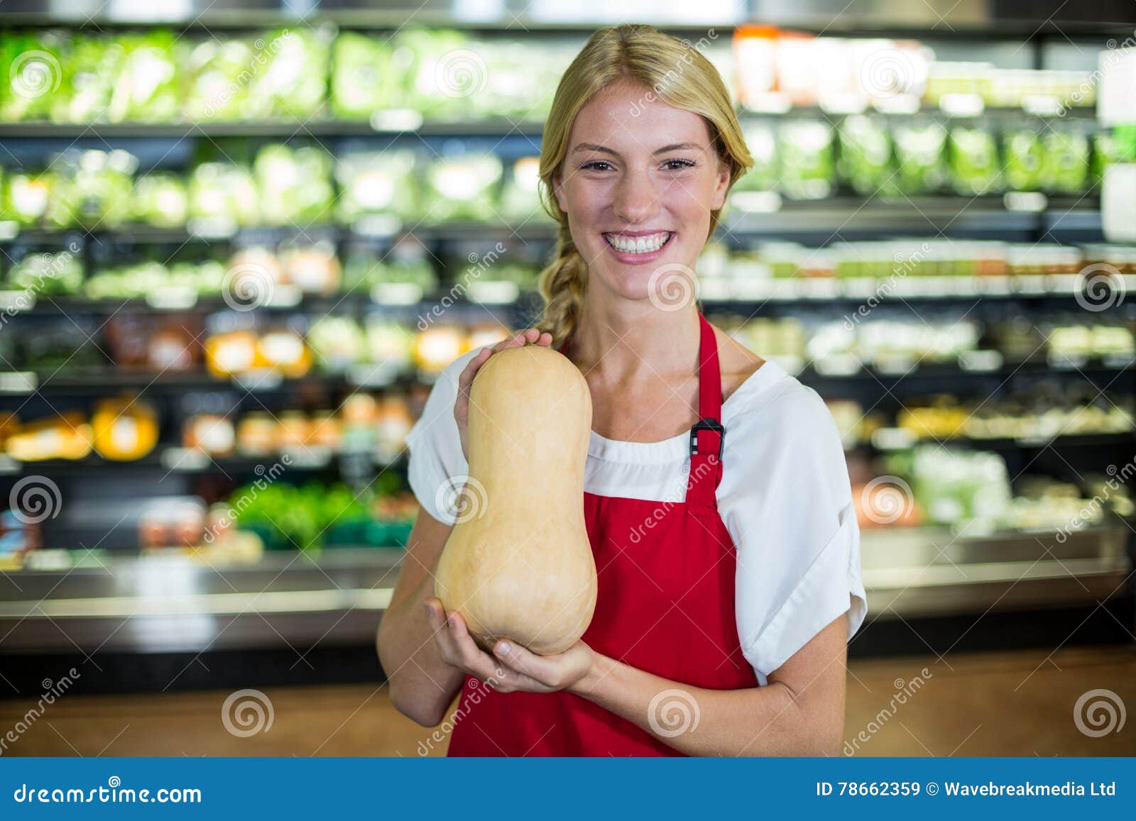 Smiling Female Staff Holding a Vegetable in Organic Section Stock Image ...