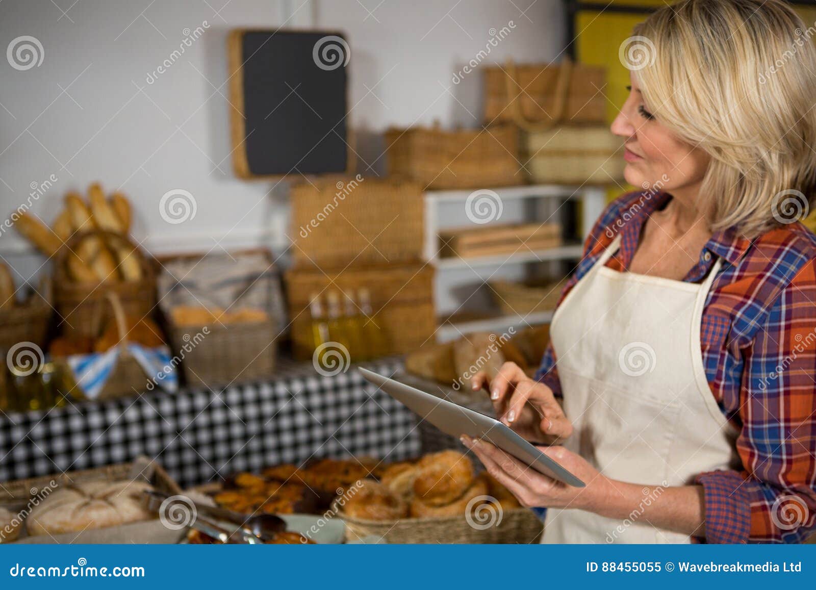 Smiling Female Staff Using Digital Tablet at Counter Stock Image ...