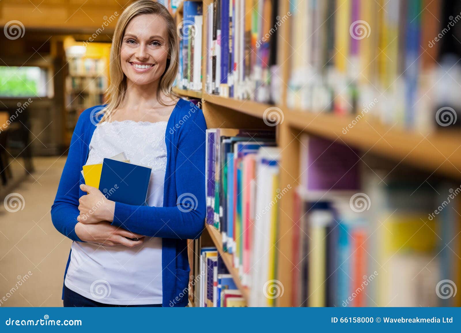 Smiling Female Student Holding a Book Stock Photo - Image of adult ...
