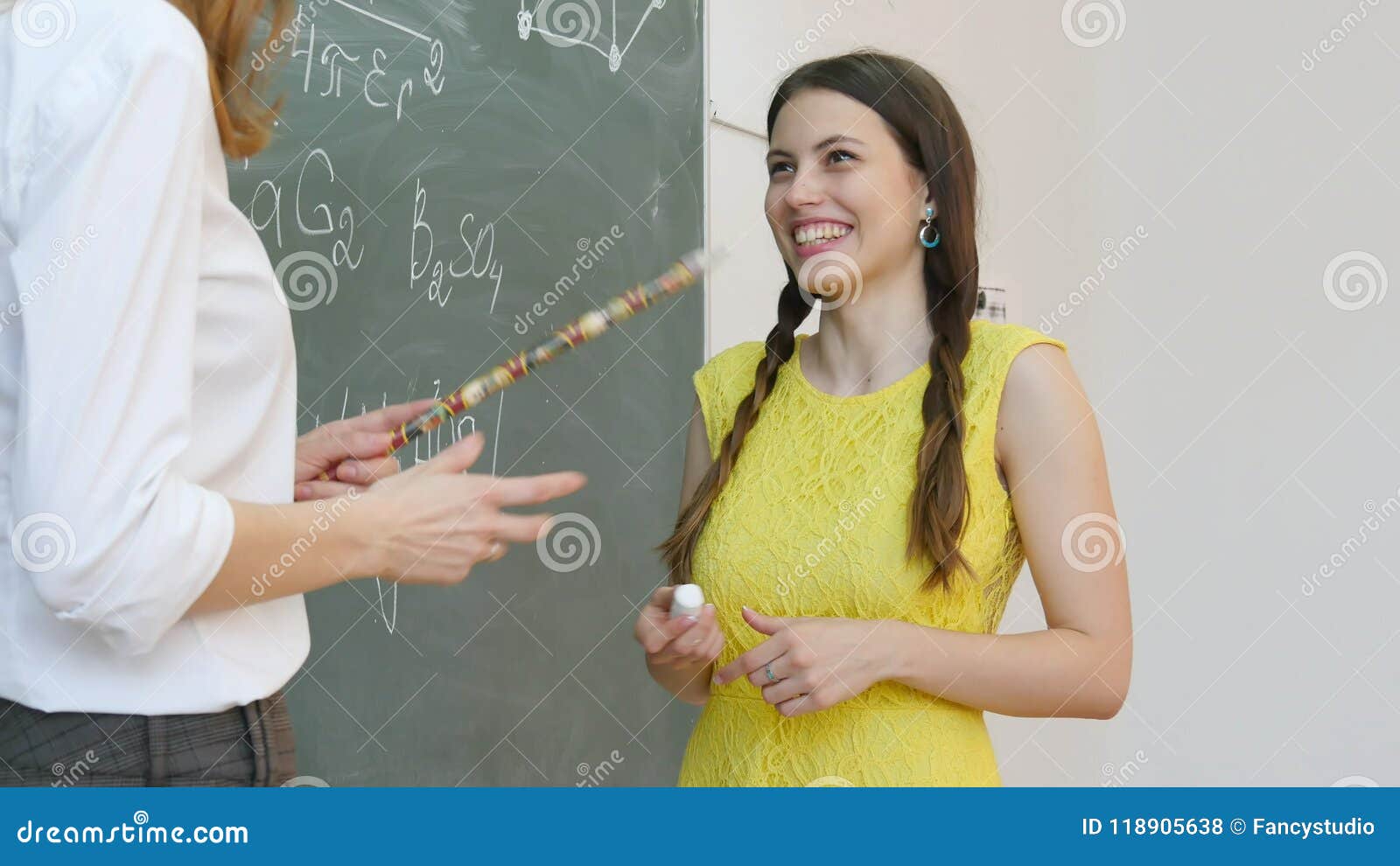 Smiling Female Student Standing in Front of the Blackboard and Answer ...