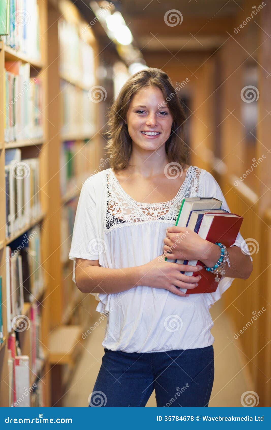 Smiling Female Student Standing in the Library Stock Photo - Image of ...