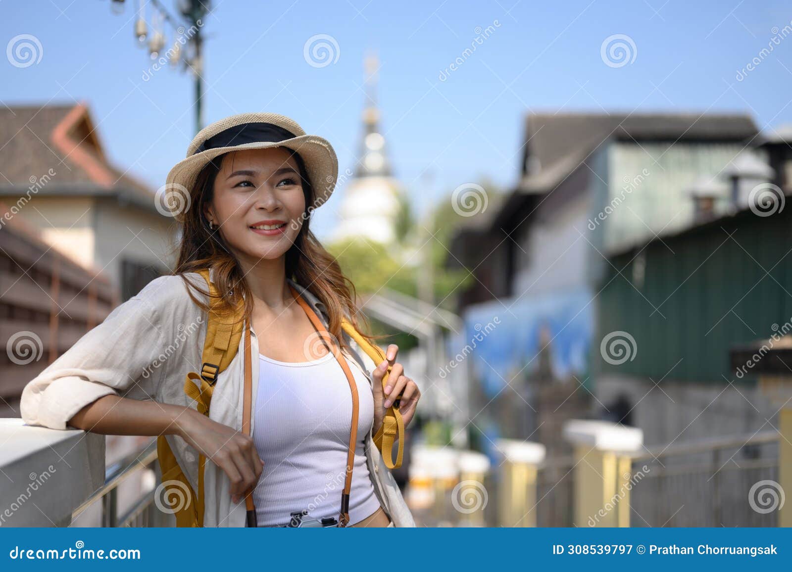 Smiling Female Traveller with Backpack Standing on Bridge and Enjoy ...