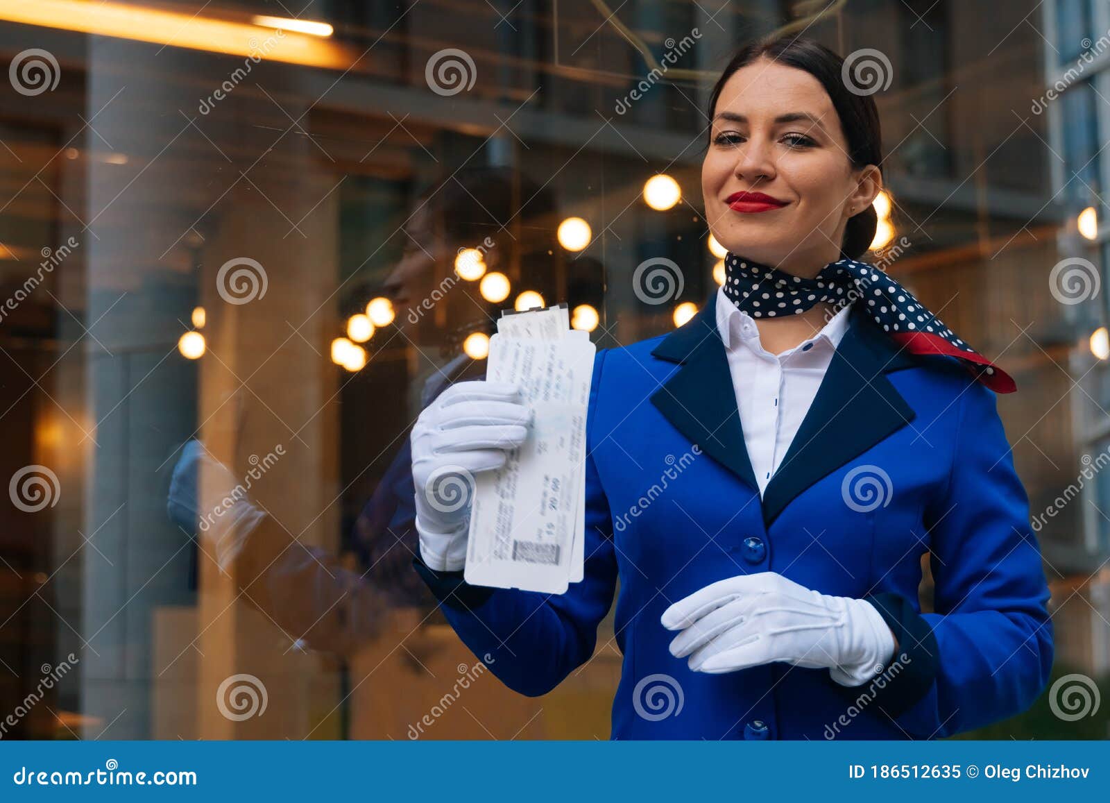 A Smiling Flight Attendant Holds a Boarding Pass. Portrait of a Young ... A Smiling Flight Attendant Holds a Boarding Pass. Portrait of a Young ...