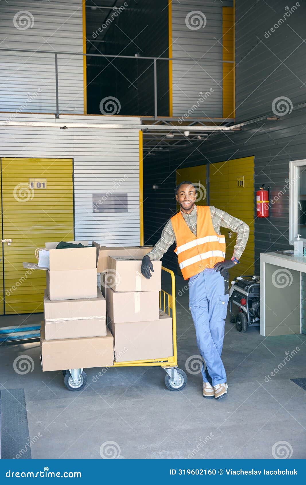 Smiling Freight Handler Posing for Camera in Workplace Stock Photo ...