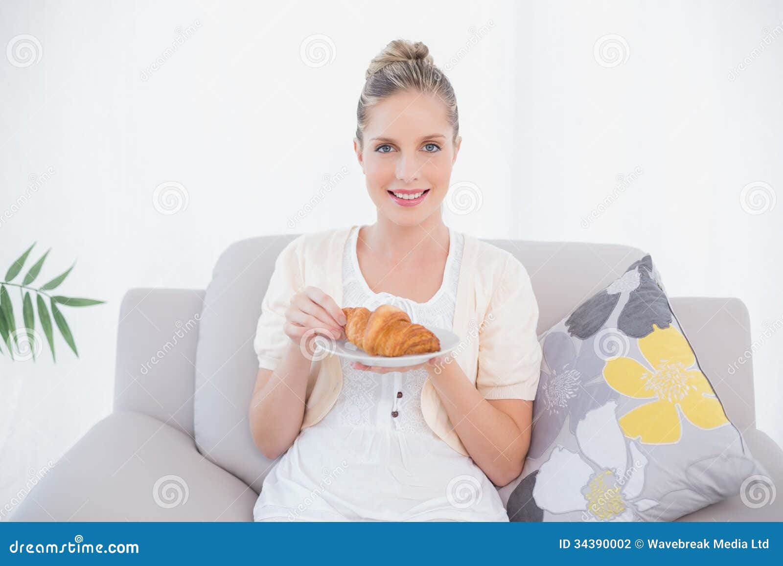 Smiling Fresh Model Having Breakfast Sitting on Sofa Stock Photo ...