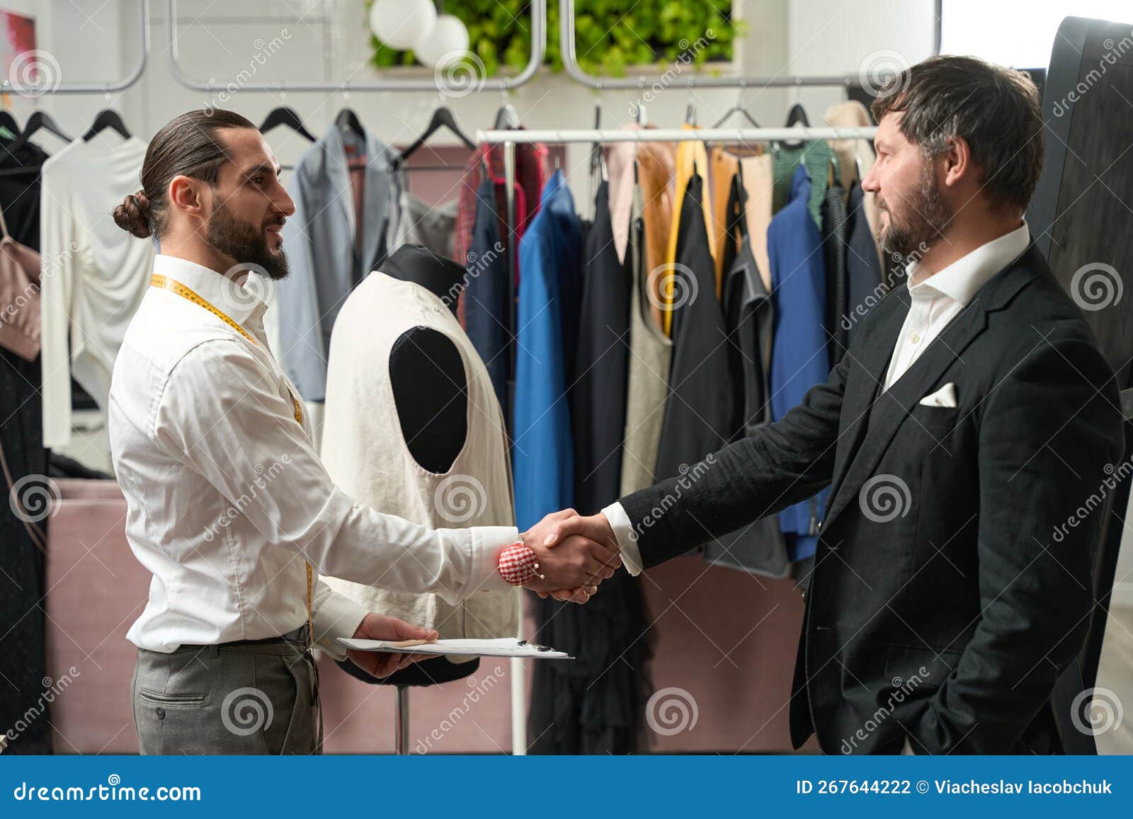 Smiling Friendly Clothier Greeting Client in Studio Stock Photo - Image ...
