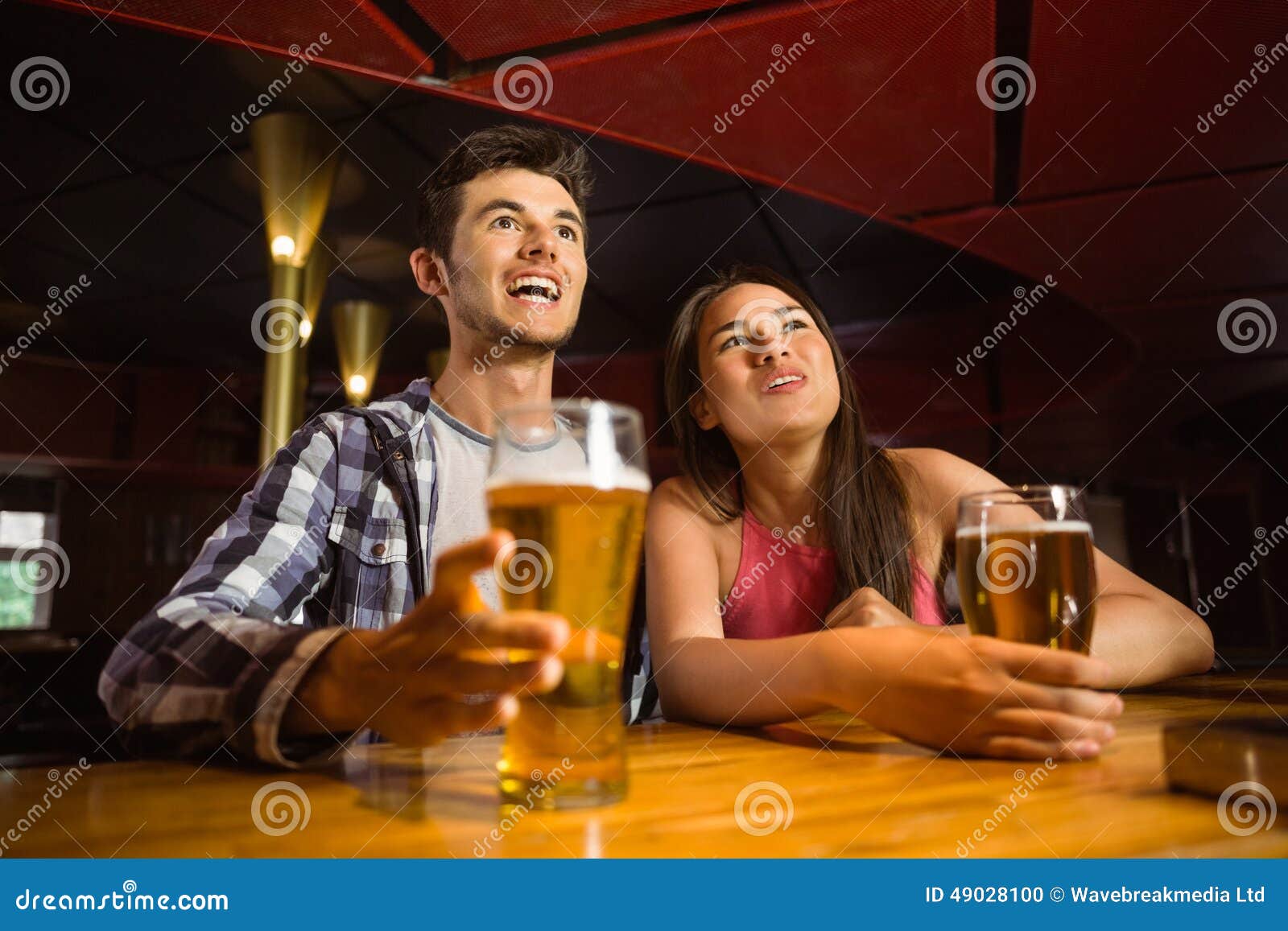 Smiling Friends Drinking Beer Together Stock Photo - Image of woman ...