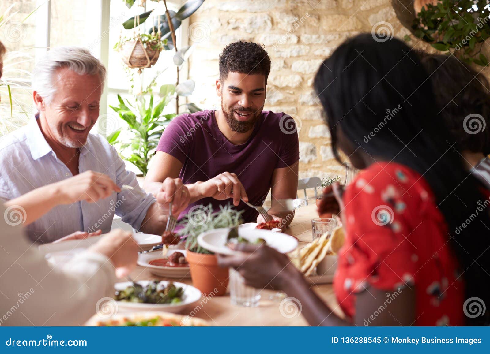 Smiling Friends Eating Together at a Table in a Cafe Stock Image ...