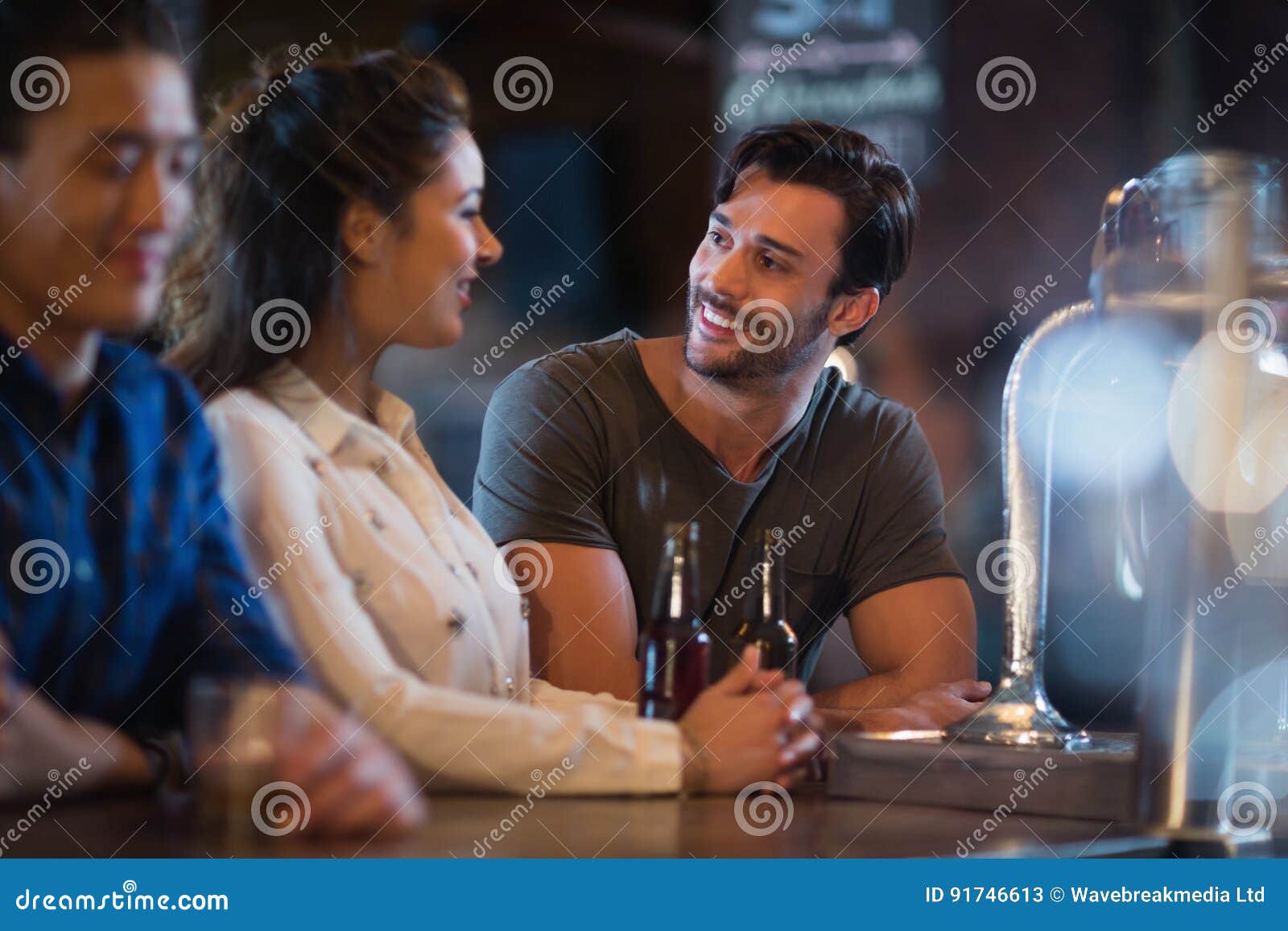 Smiling Friends Interacting at Bar Counter Stock Image - Image of adult ...