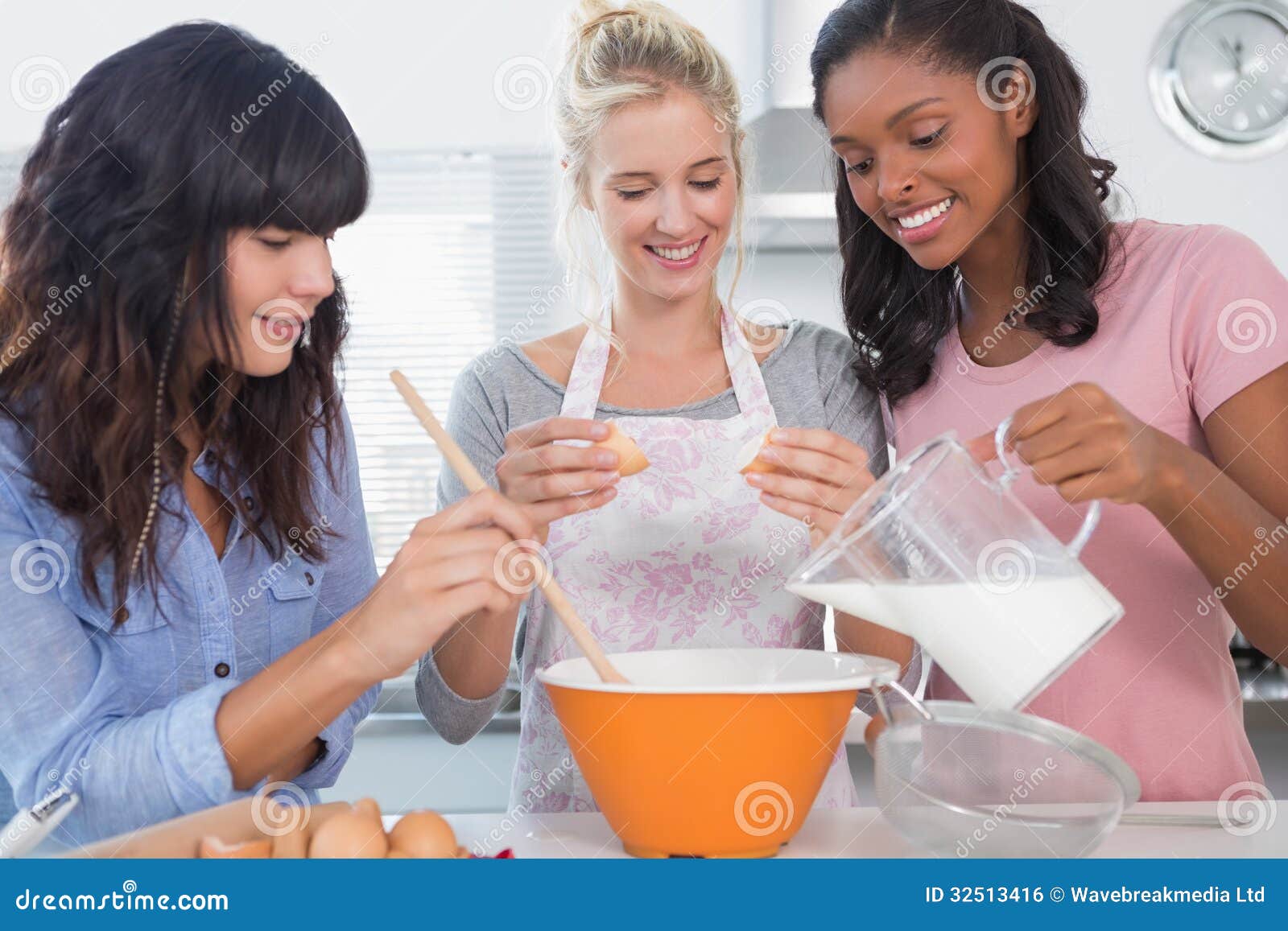 Smiling Friends Making Pastry Together Stock Photo - Image of brunette ...