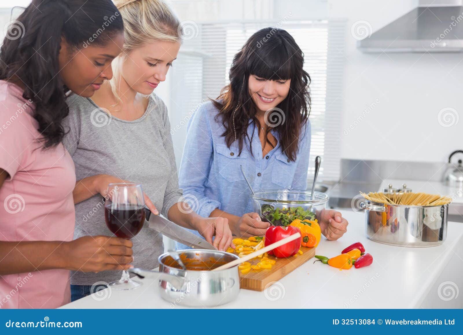 Smiling Friends Preparing a Meal Together Stock Photo - Image of ...
