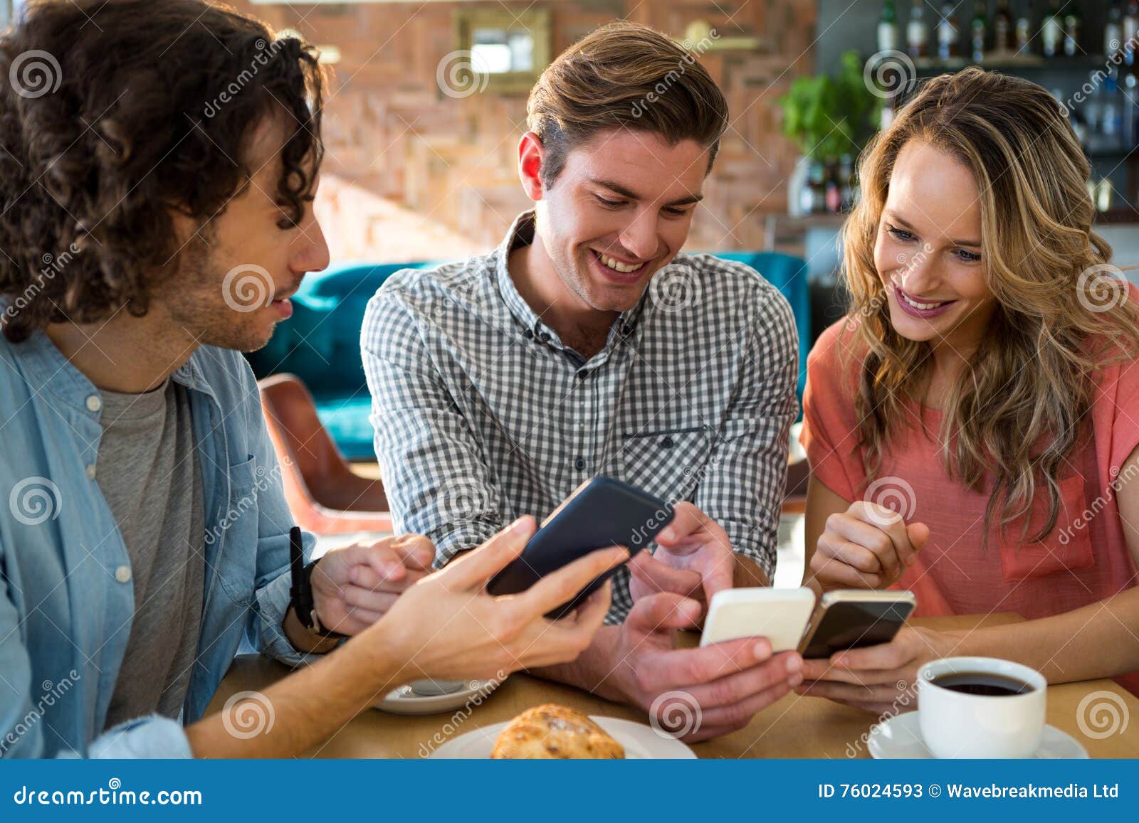Smiling Friends Using Their Mobile Phone Stock Image - Image of ...