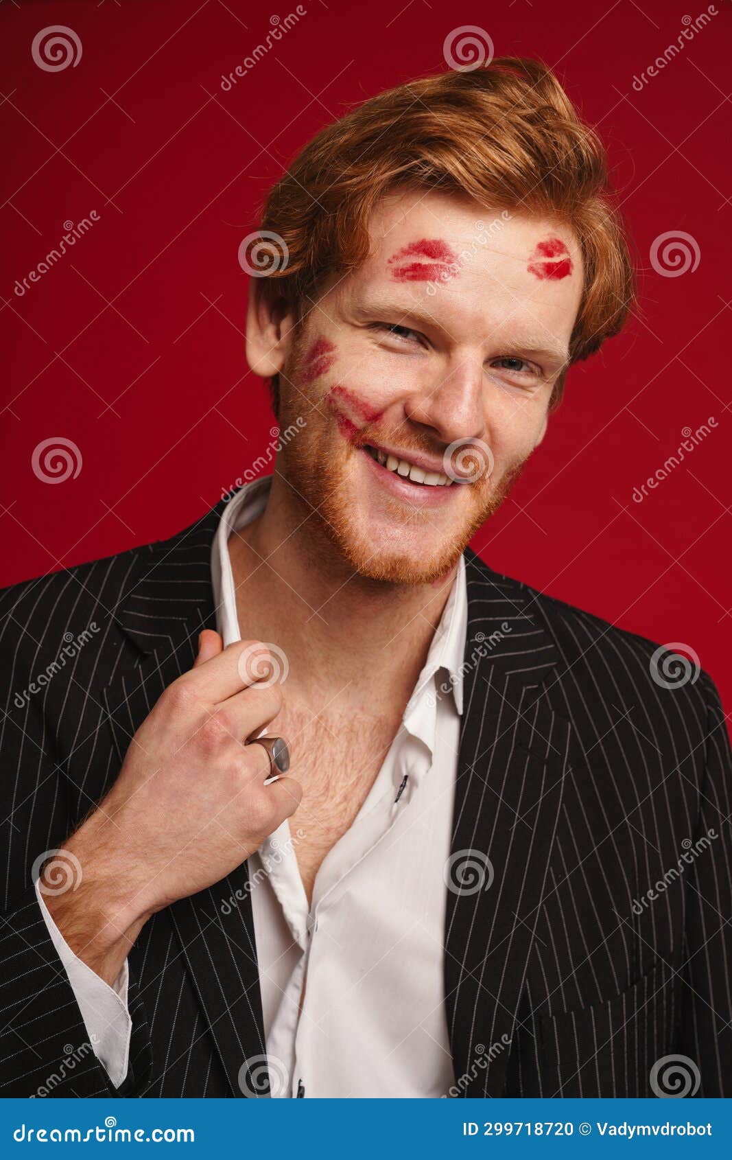 Man with Lipstick Marks on Face Posing Isolated Over Red Wall Stock ...