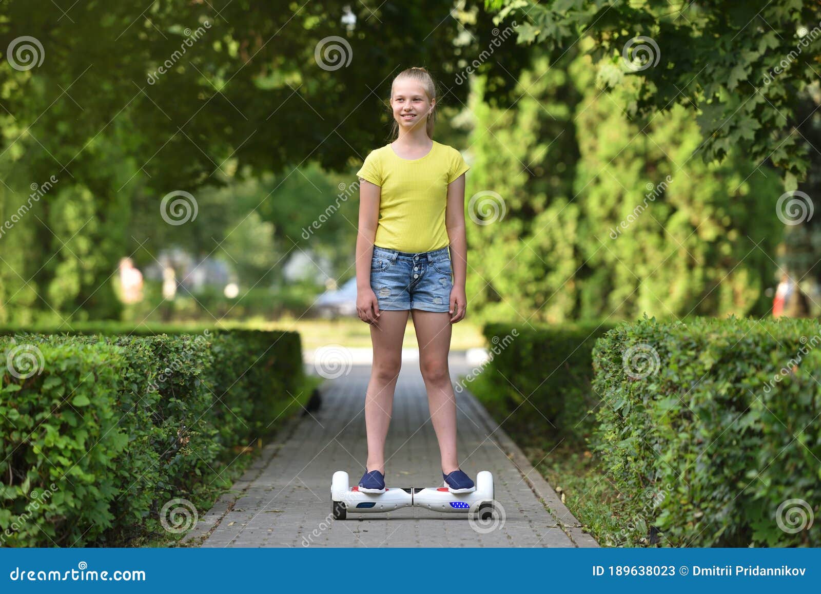 Smiling Girl Child Riding a Hoverboard in a Park on a Background of ...