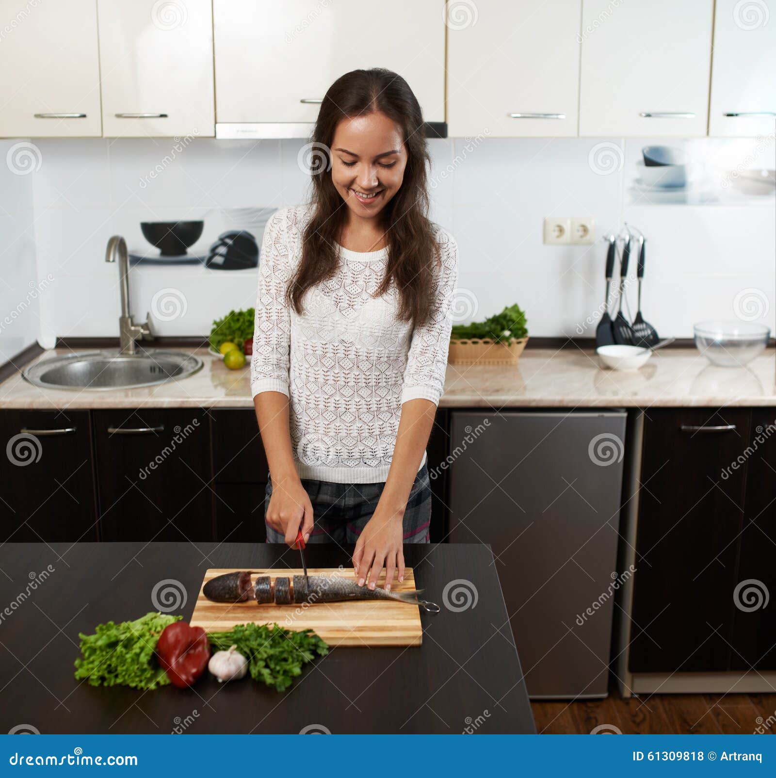 Smiling girl cut fish stock photo. Image of indoor, dish - 61309818