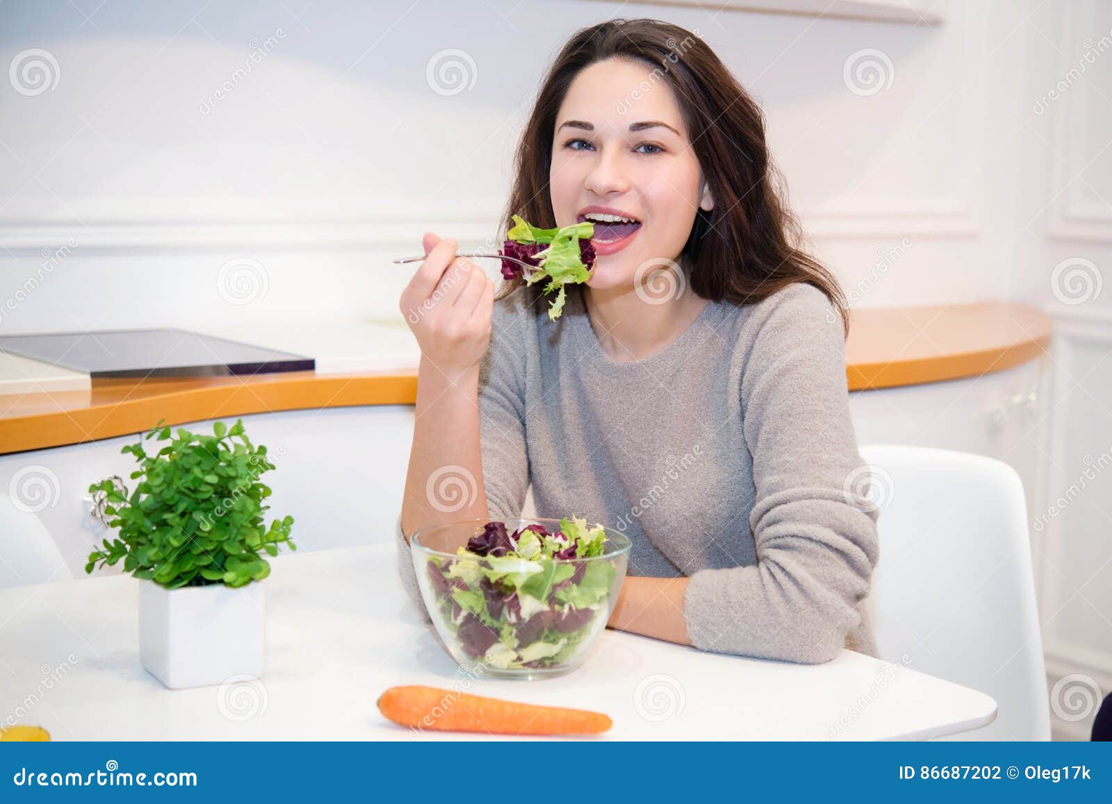 Smiling girl eating salad stock photo. Image of diet - 86687202