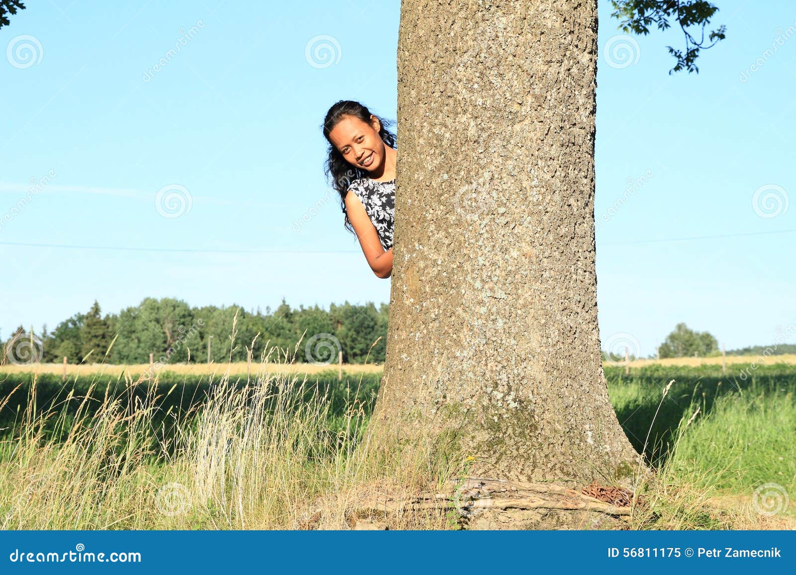Woman Hiding Behind Tree