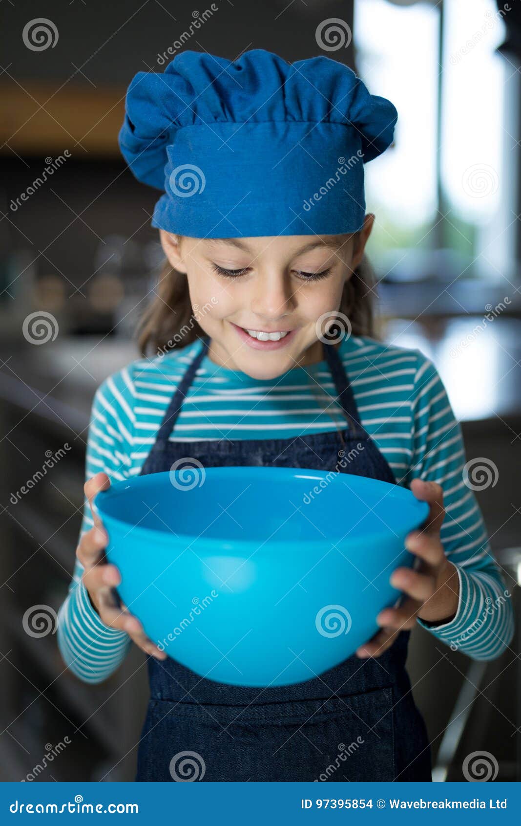 Smiling Girl Looking into the Bowl in the Kitchen Stock Photo - Image ...