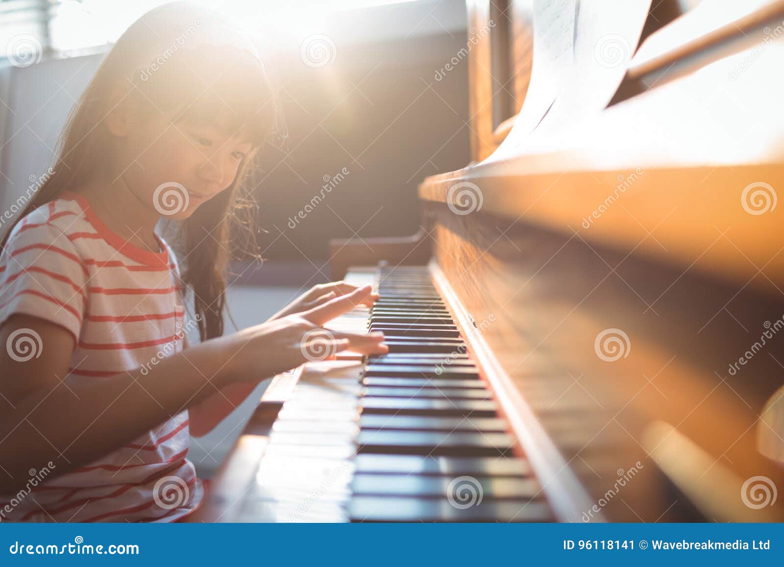 Smiling Girl Practicing Piano in Classroom Stock Image - Image of ...
