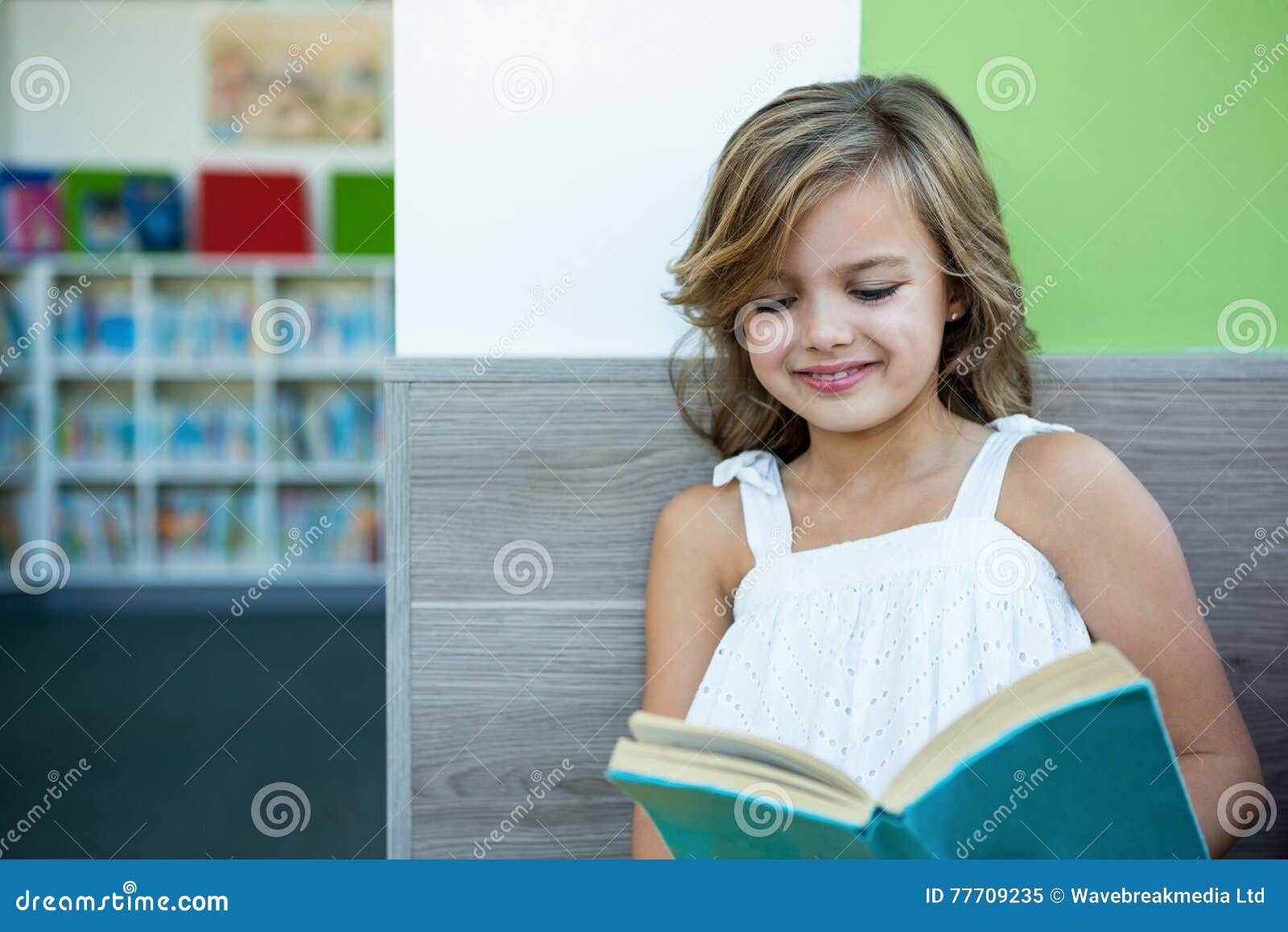 Smiling Girl Reading Book in School Library Stock Image - Image of ...