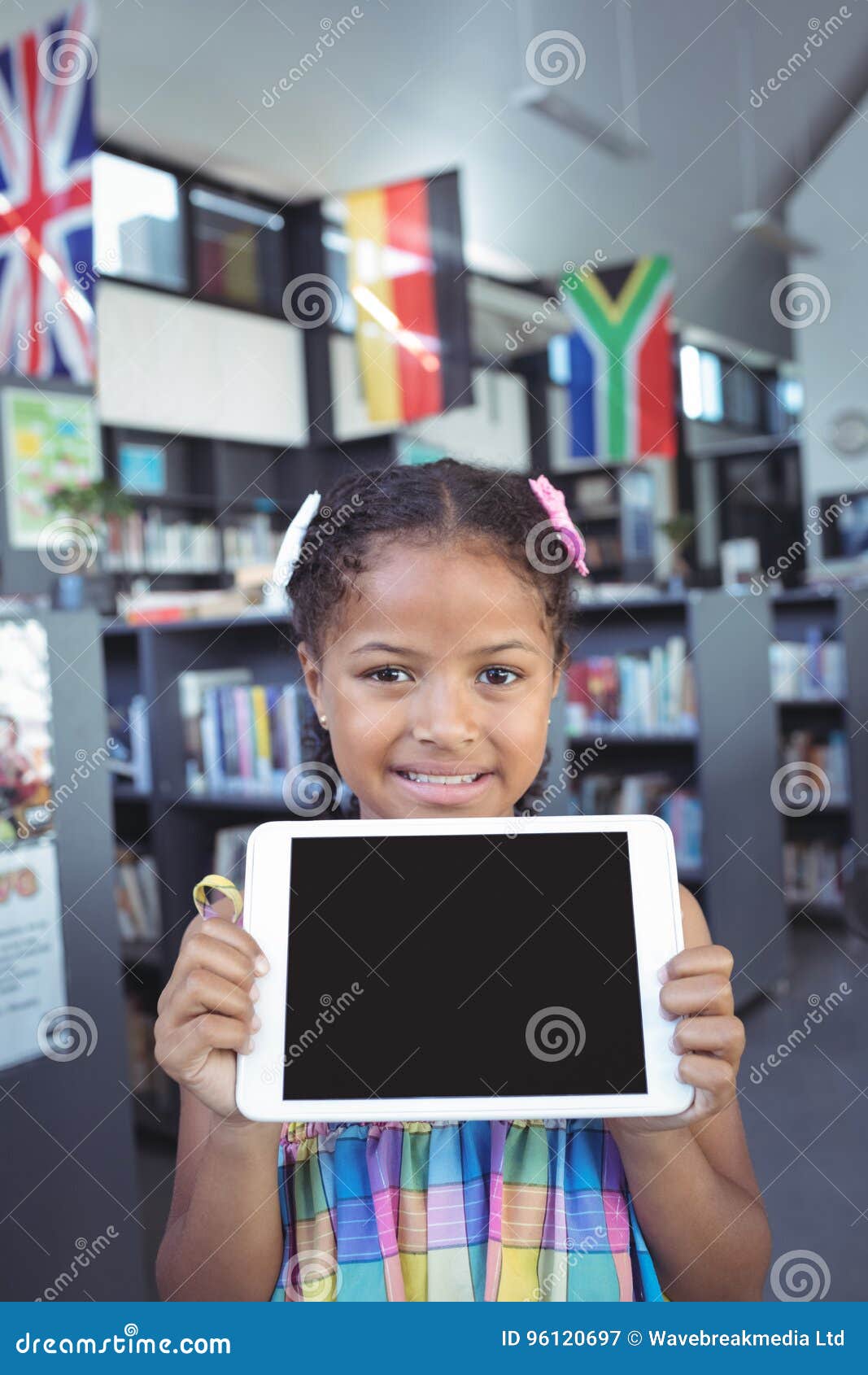 Smiling Girl Showing Tablet Computer in Library Stock Image - Image of ...