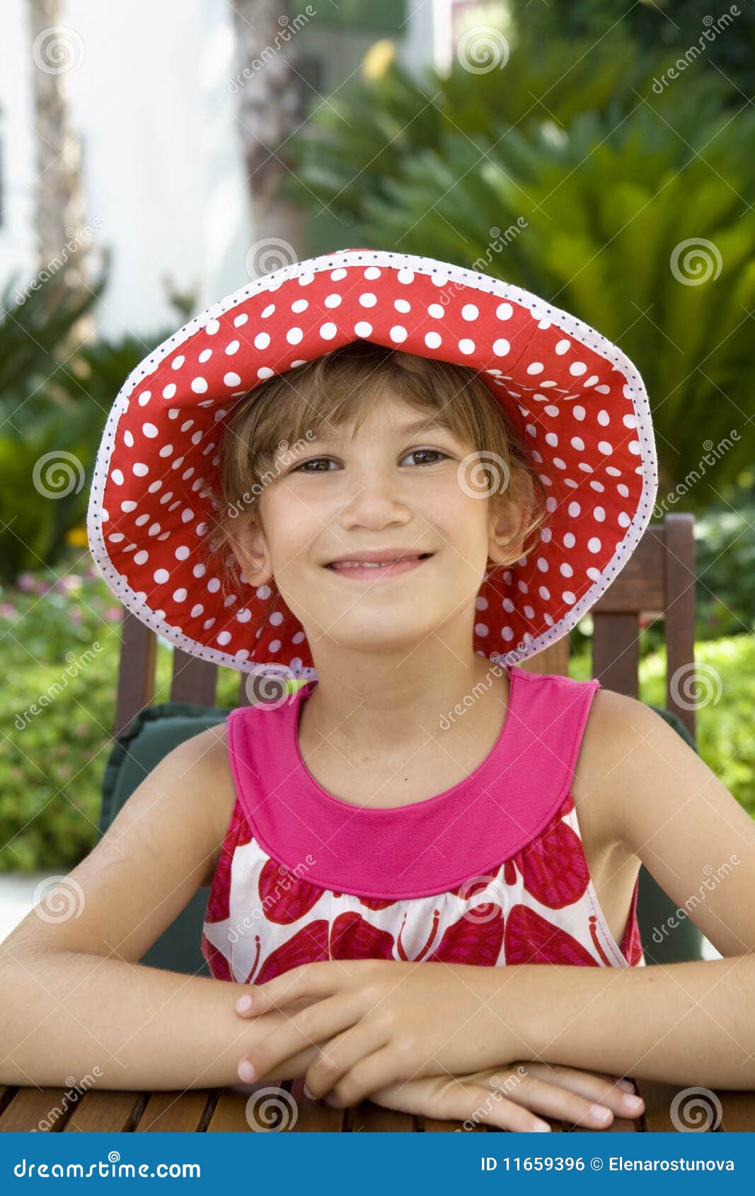 Smiling Girl Sitting at Table Stock Photo - Image of white, outdoor ...