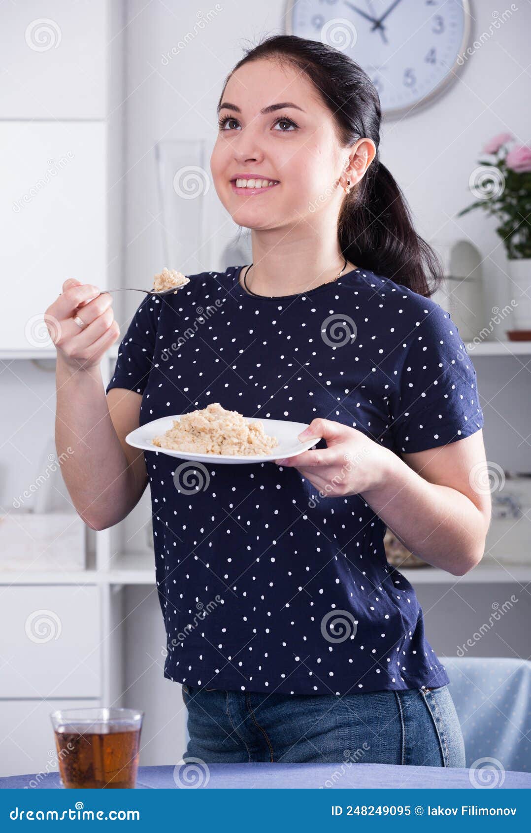 Smiling Girl Standing and Eating Stock Image - Image of eating, home ...
