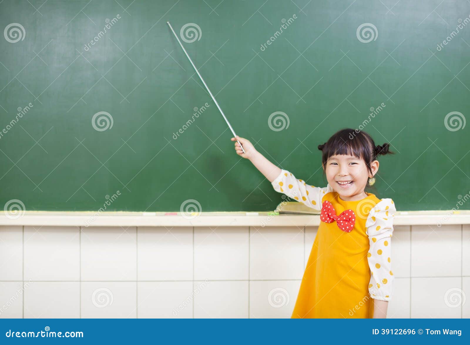 Smiling Girl Using a Baton To Point Stock Photo - Image of child, play ...