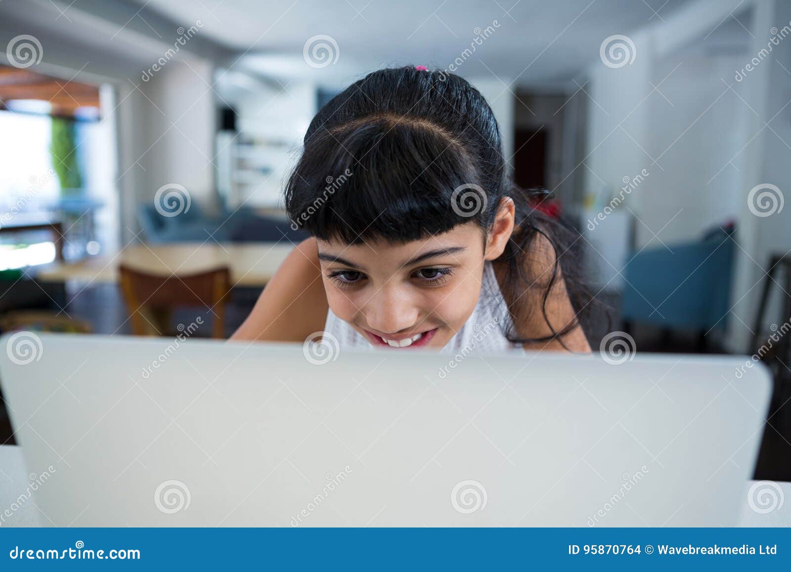 Smiling girl using laptop stock photo. Image of furniture - 95870764