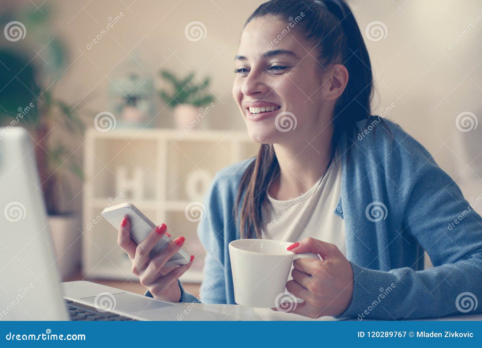 Smiling Girl Using Phone and Computer. Stock Image - Image of room ...