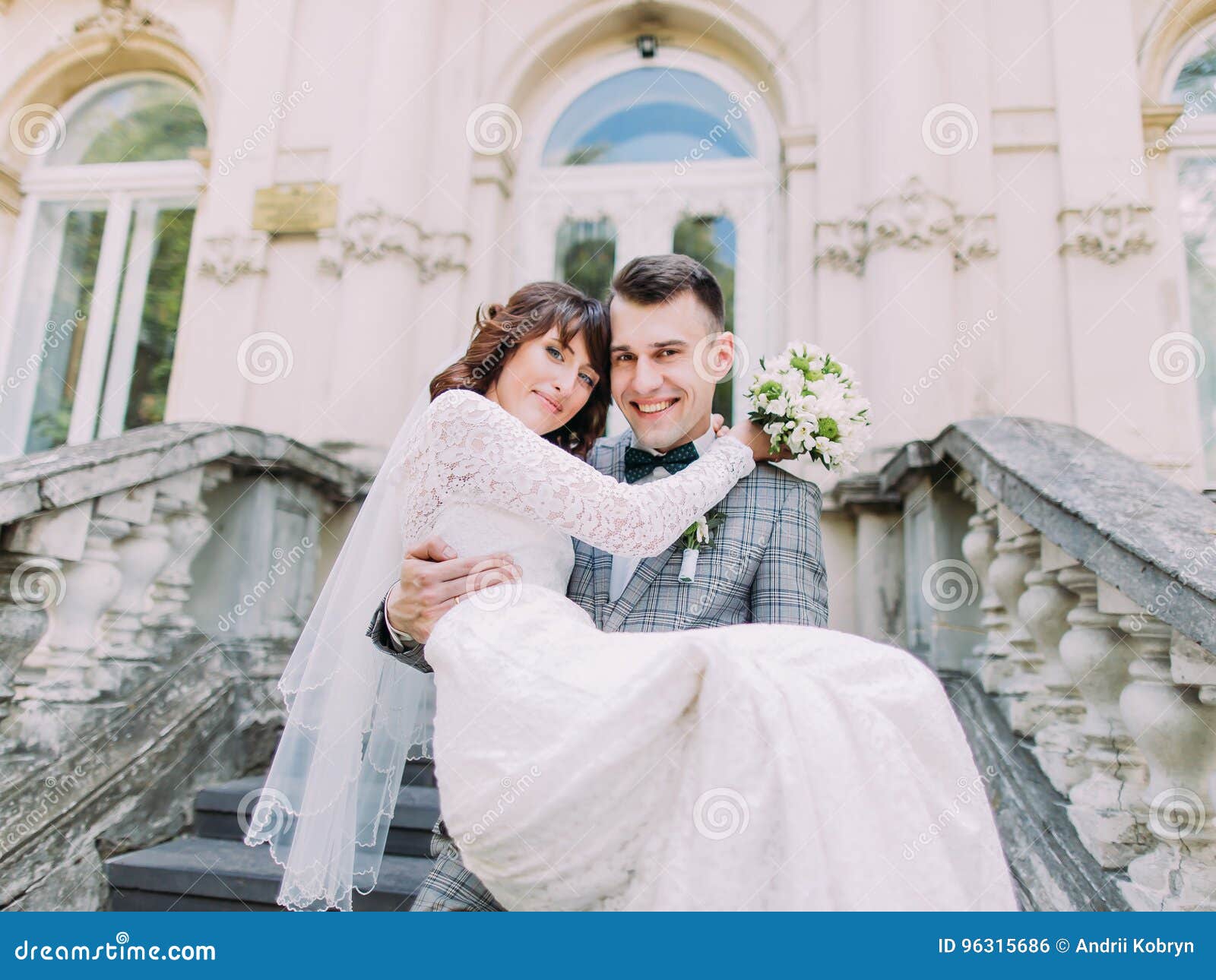 The Smiling Groom is Carrying the Cheerful Bride. the Horizontal View ...