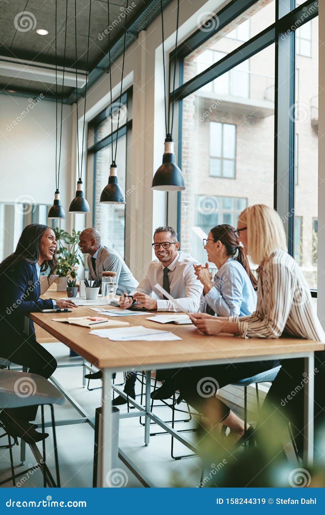 Smiling Group of Diverse Businesspeople Meeting Together in an O Stock ... Smiling Group of Diverse Businesspeople Meeting Together in an O Stock ...