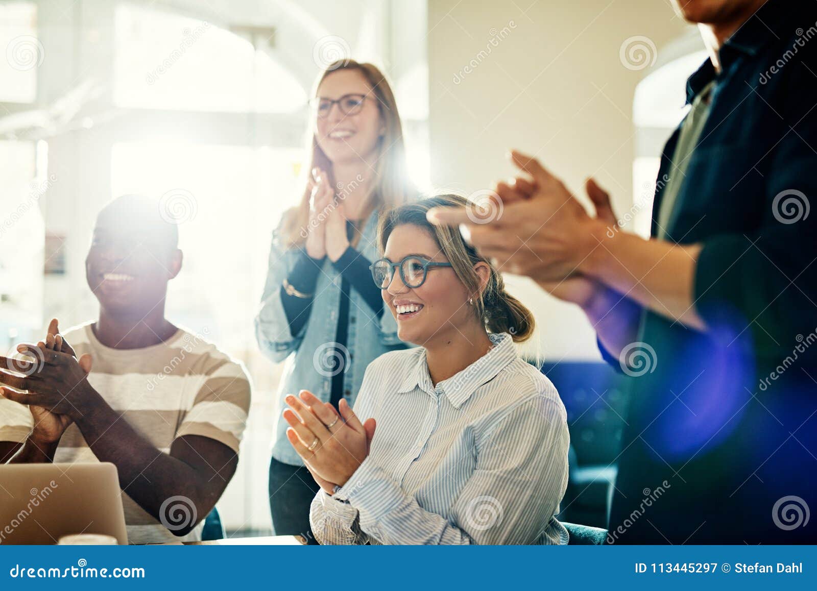 Smiling Group Of Diverse Coworkers Clapping During An Office