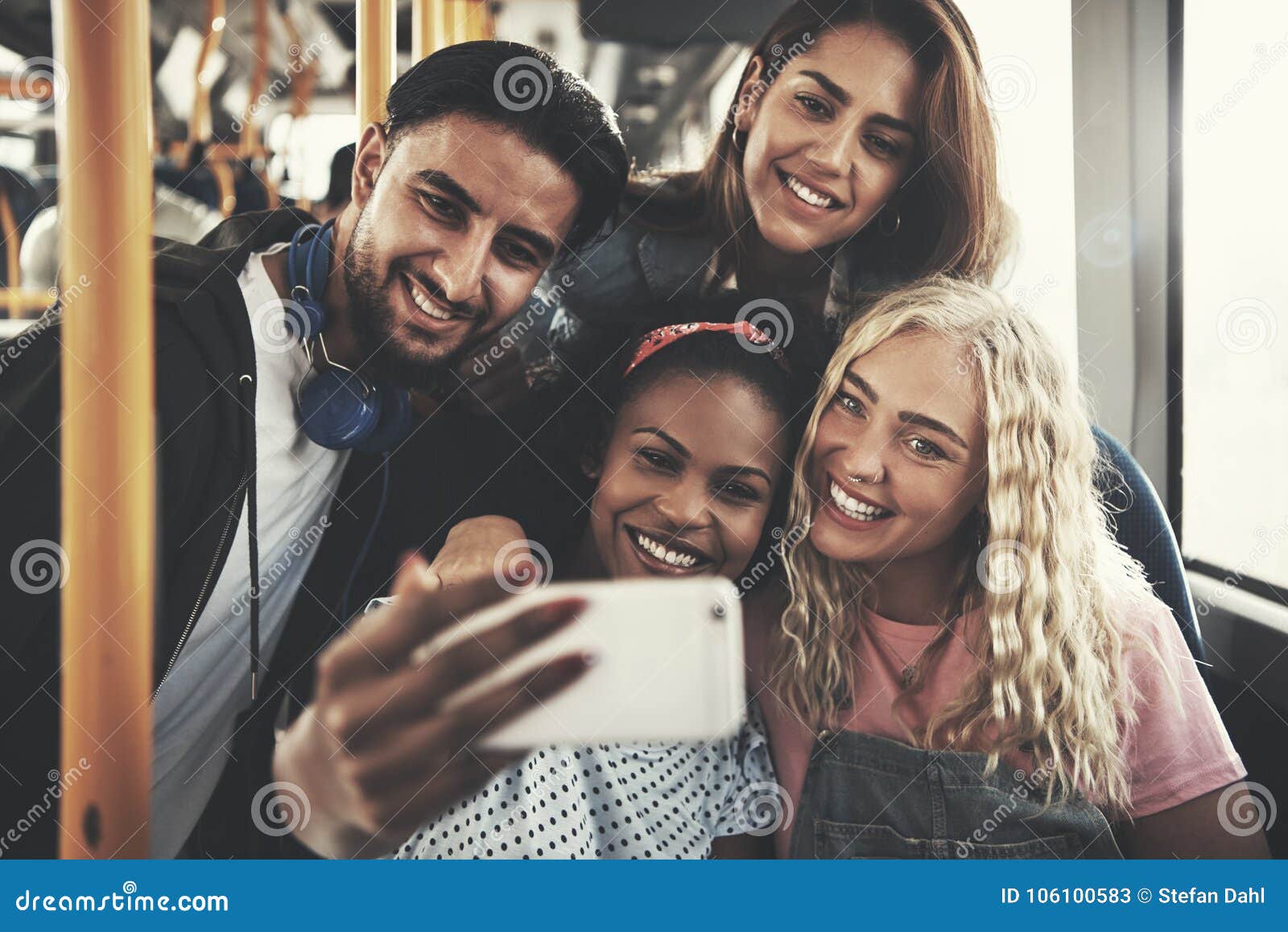 Friends Smiling And Taking Selfies Together On A Bus Stock Image