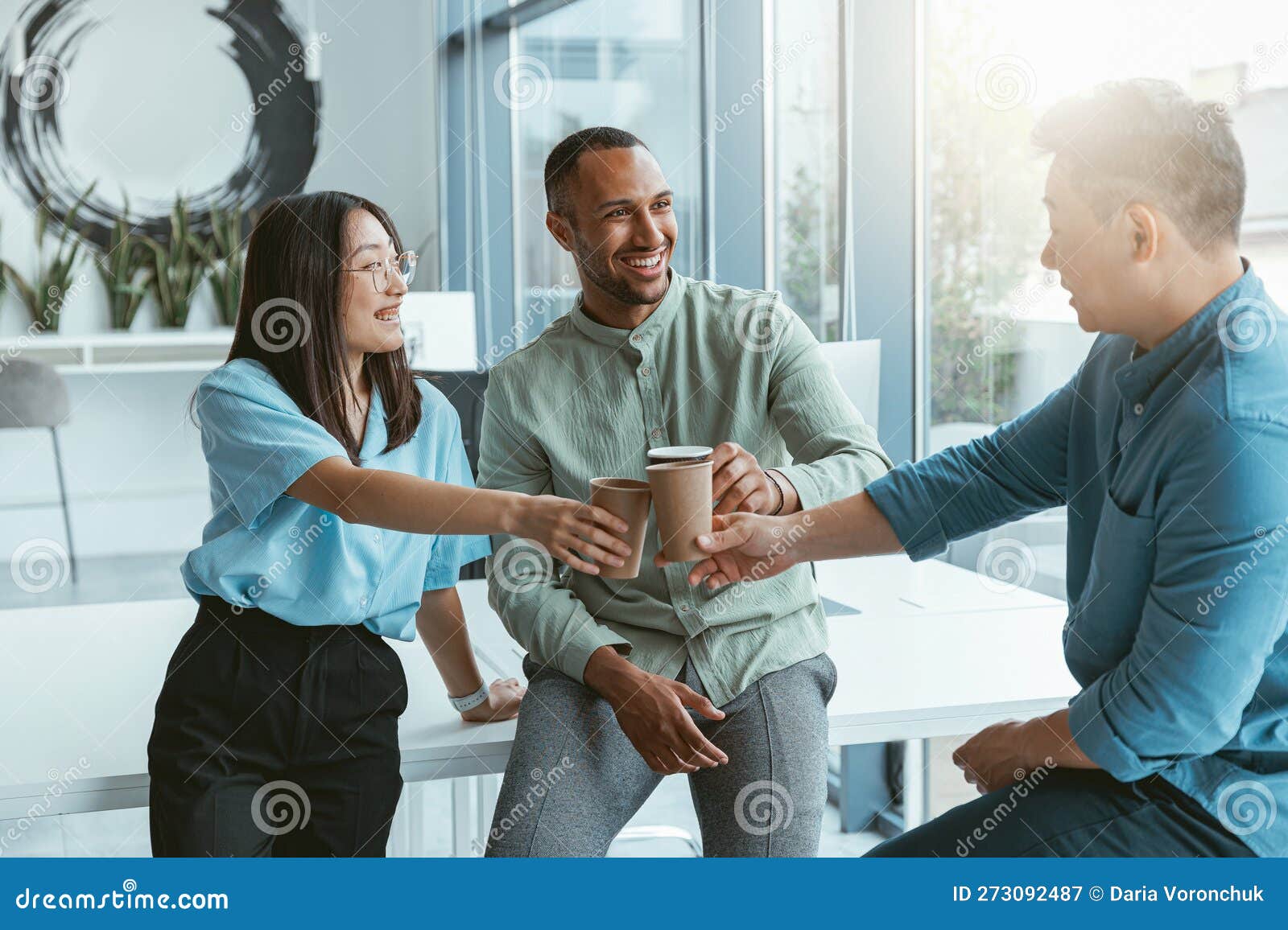 Smiling Group Of Multiethnic Colleagues Drinking Coffee And Talking
