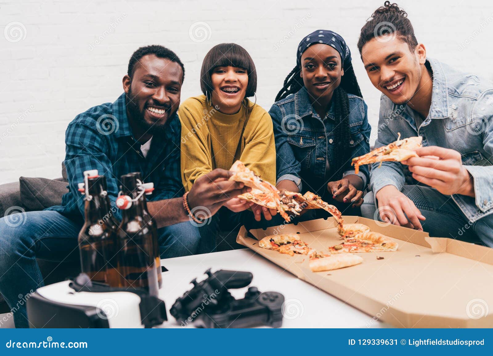 Smiling Group of Young Multicultural Friends Eating Stock Image - Image ...